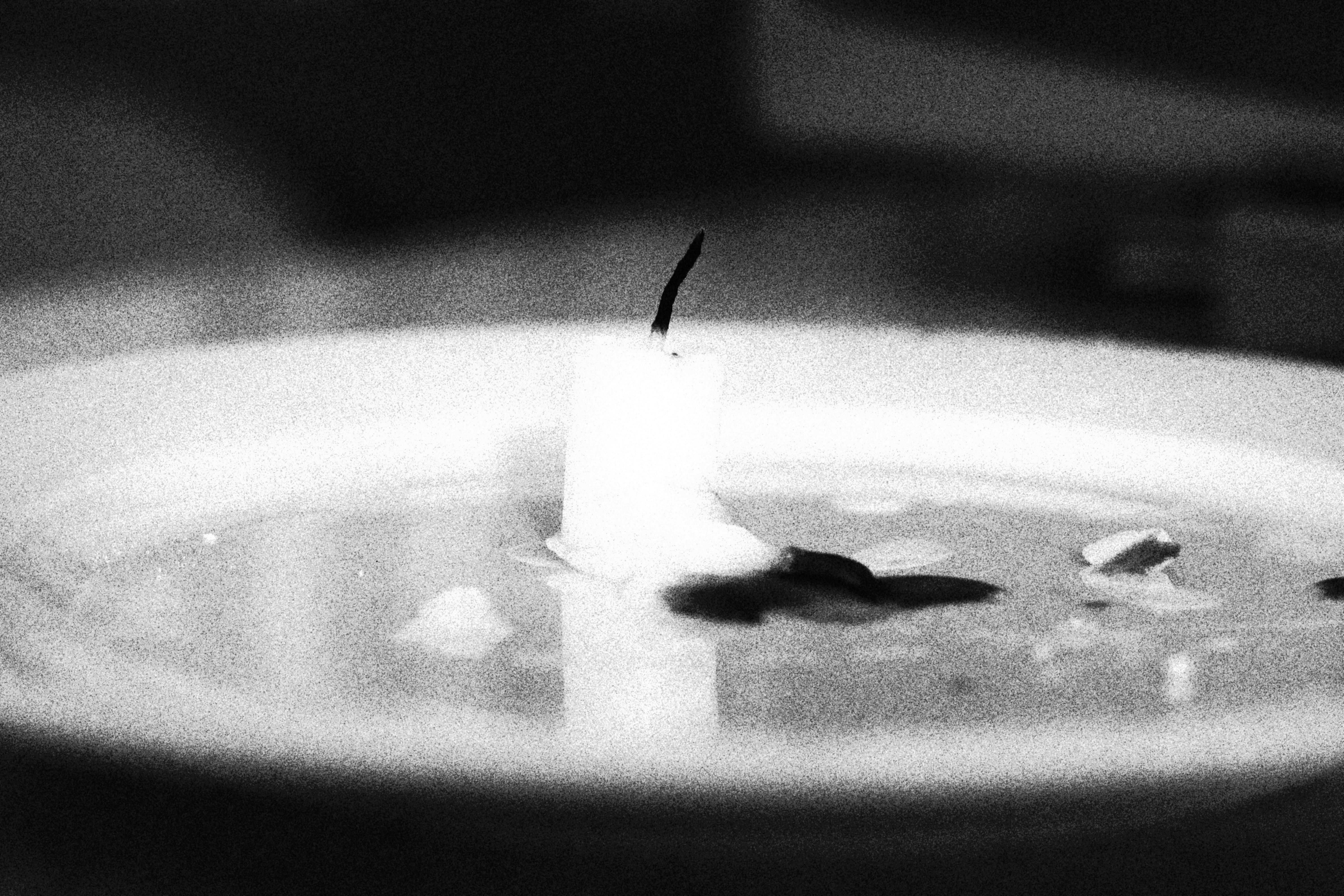Whisper of Light: A Mono Candle Flicker on a Quiet Plate