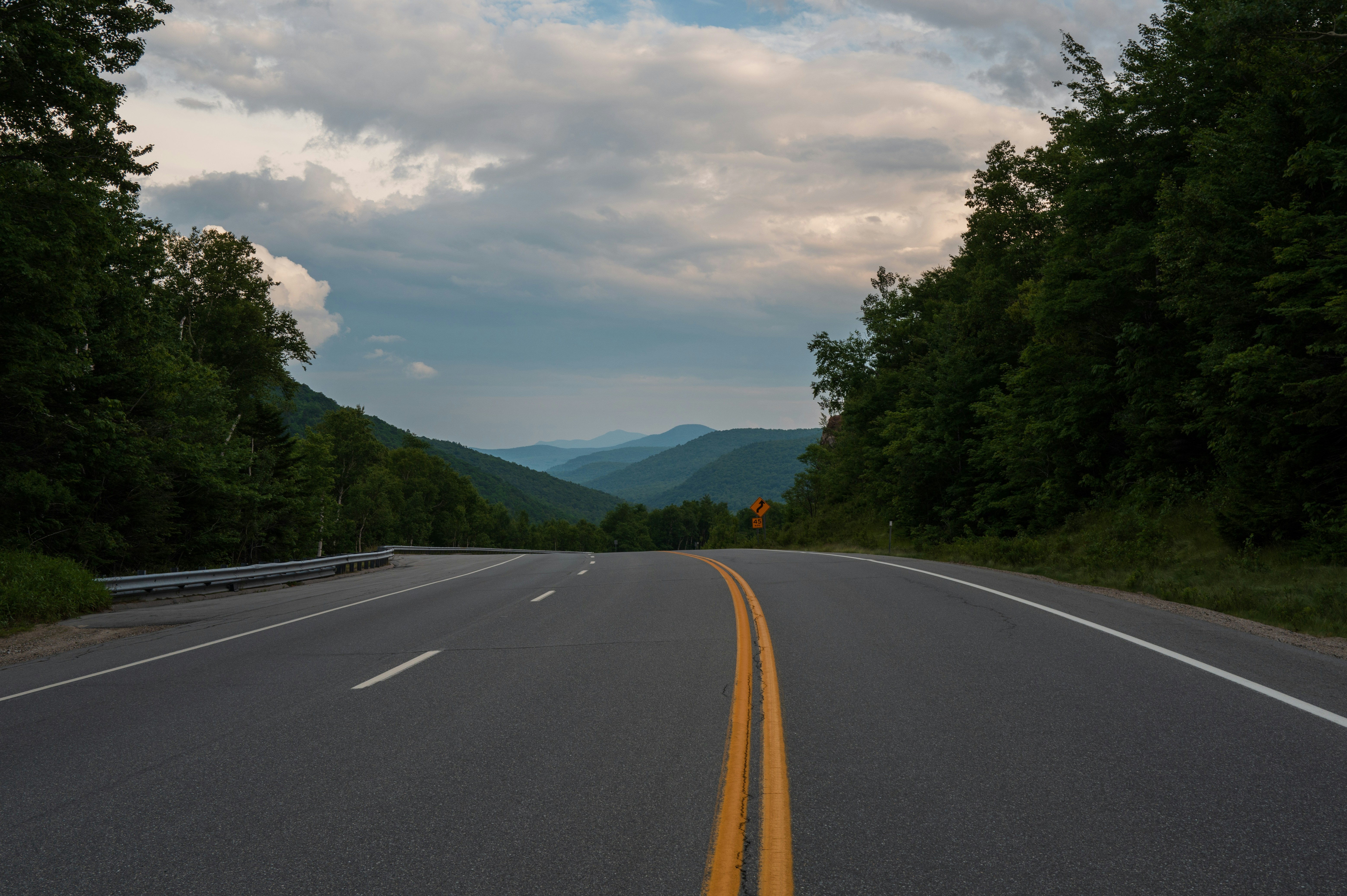 A road with a yellow line on the side of it photo – Free Road Image on ...