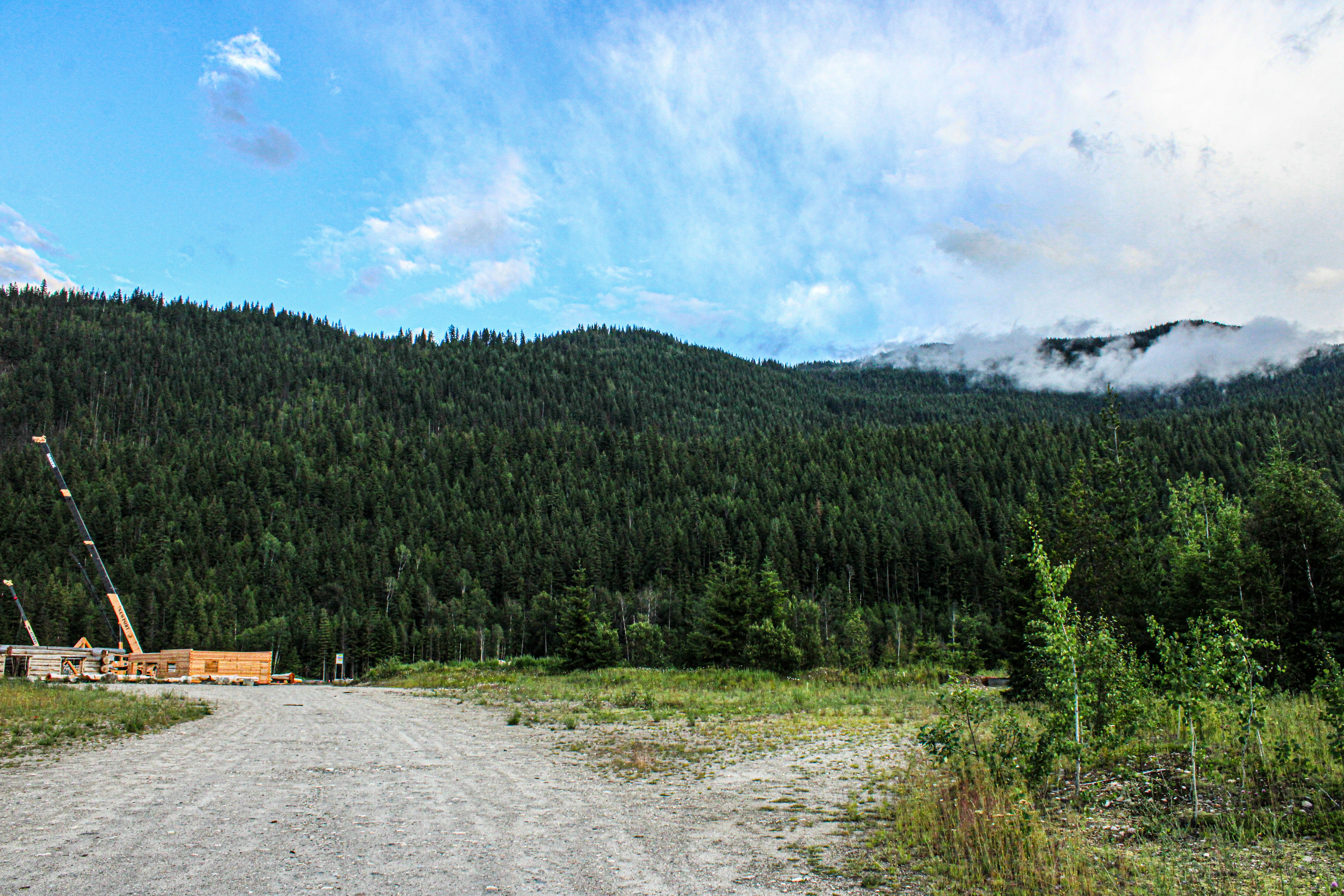 Gravel Road into the Pines: Crane Quietly Framing a New Build
