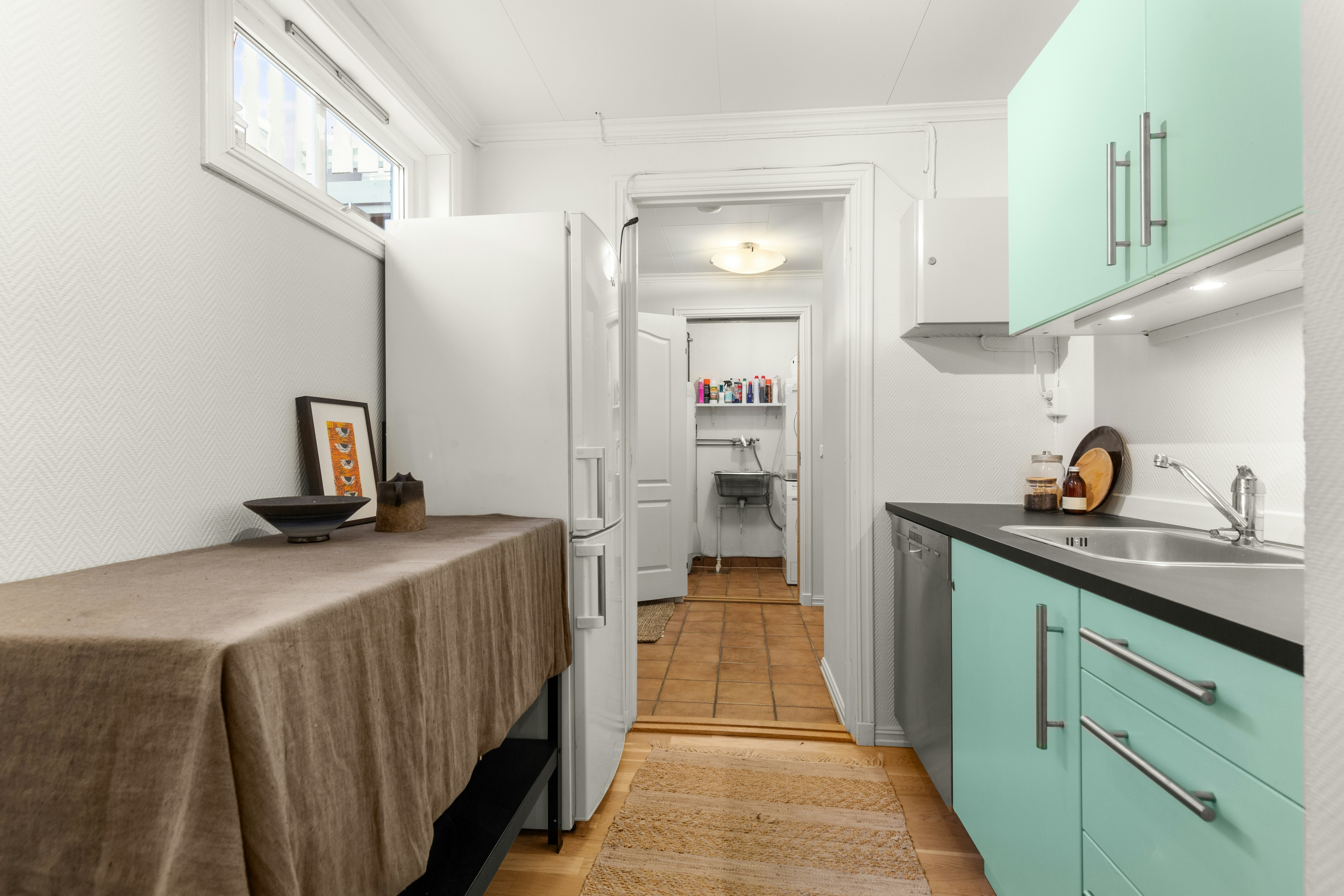 A long narrow kitchen with a table in the middle photo – Free Indoors ...