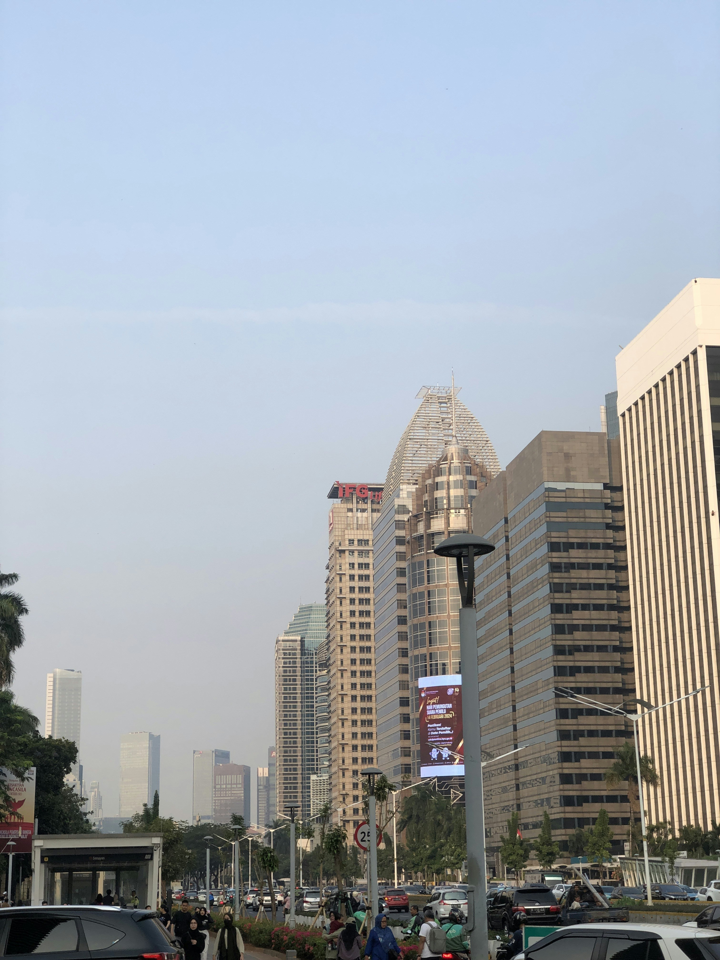 A bustling cityscape featuring a blend of contemporary skyscrapers and urban life. The scene captures the dynamic essence of city living.