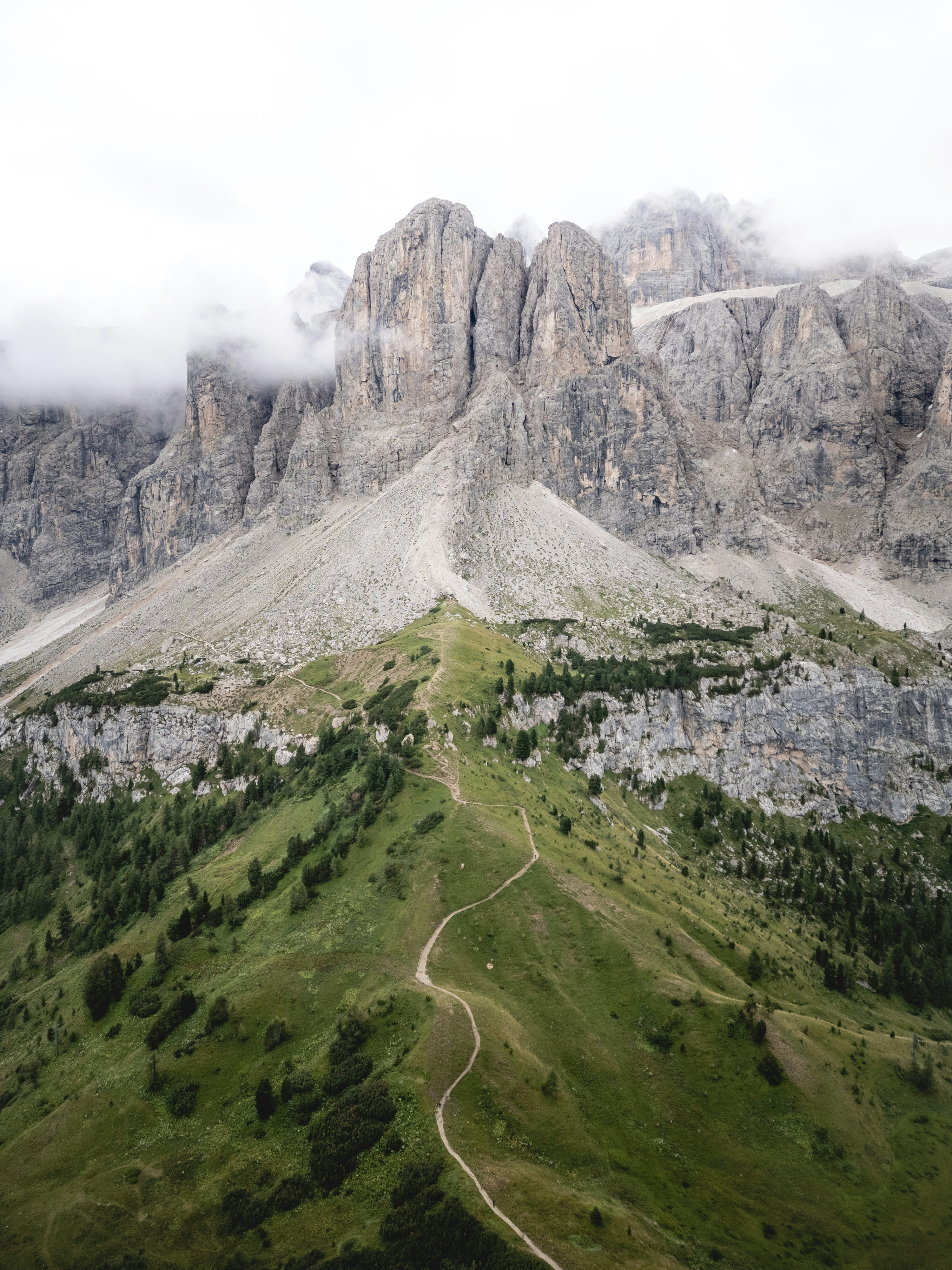 A view of a mountain with a trail going through it photo – Free ...