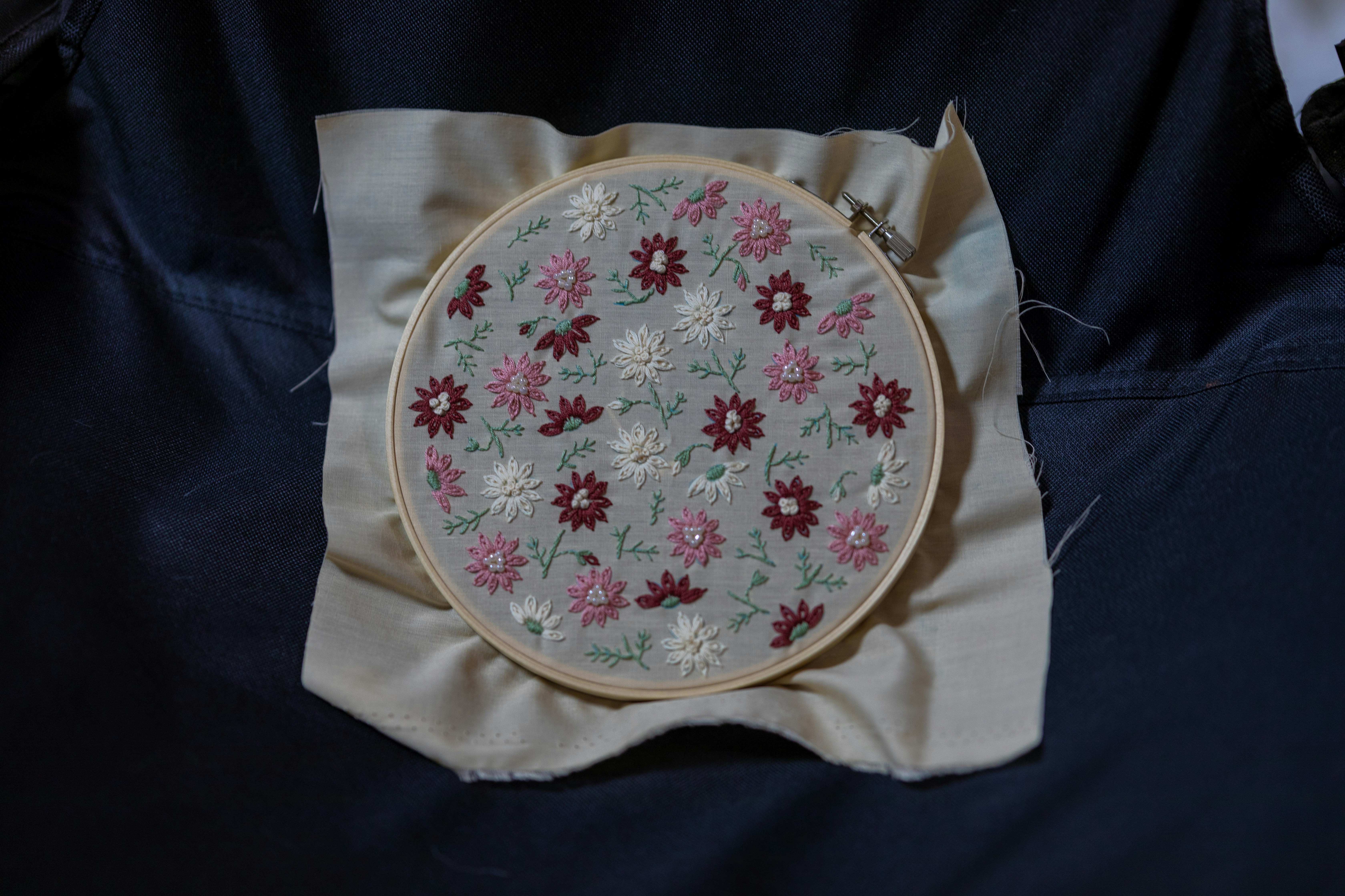 Floral Threads in a Quiet Light: Embroidery Hoop on Cream Fabric