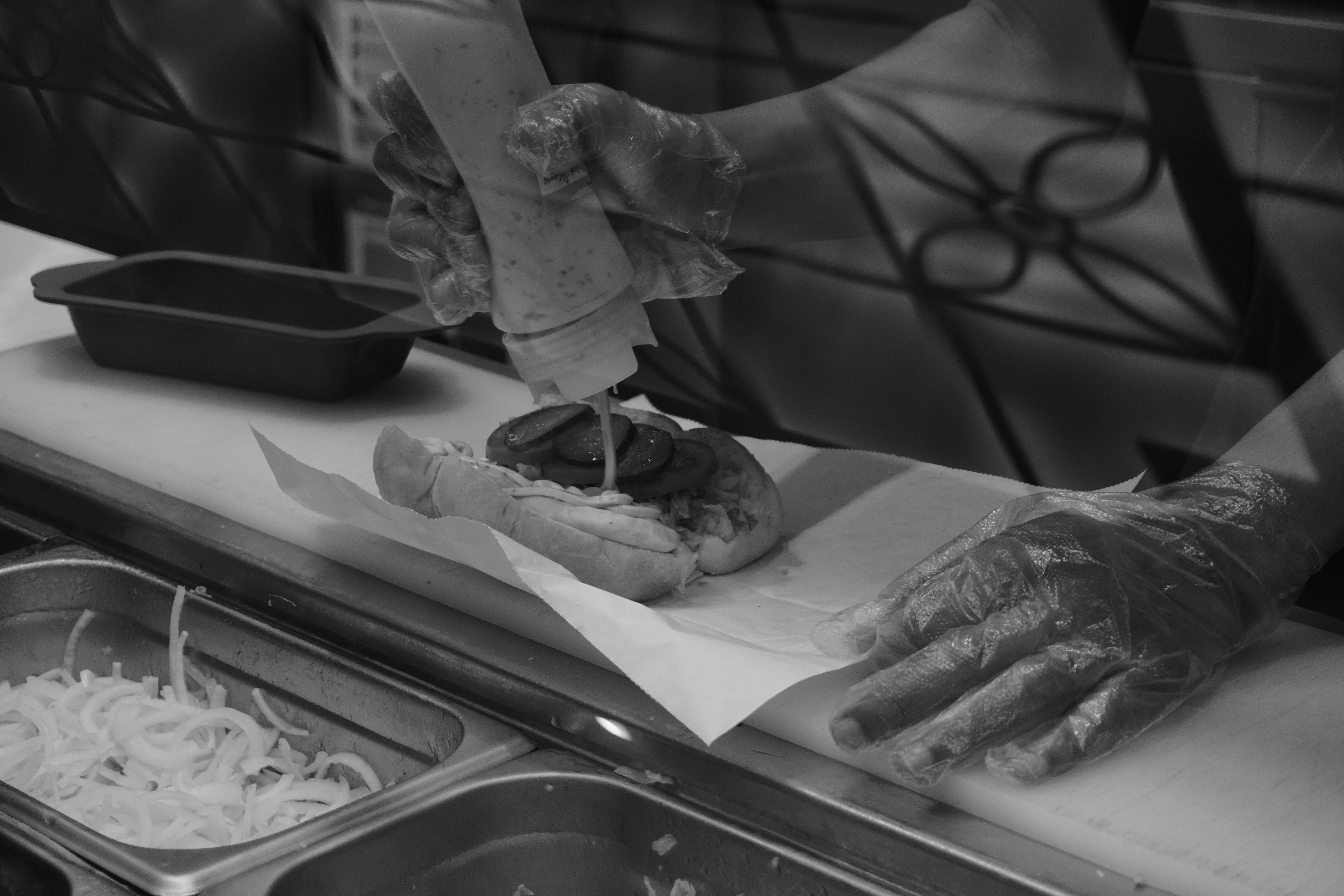 Handcrafted Toppings: Pour-over of Sauce on a Build-Your-Own Hot Dog