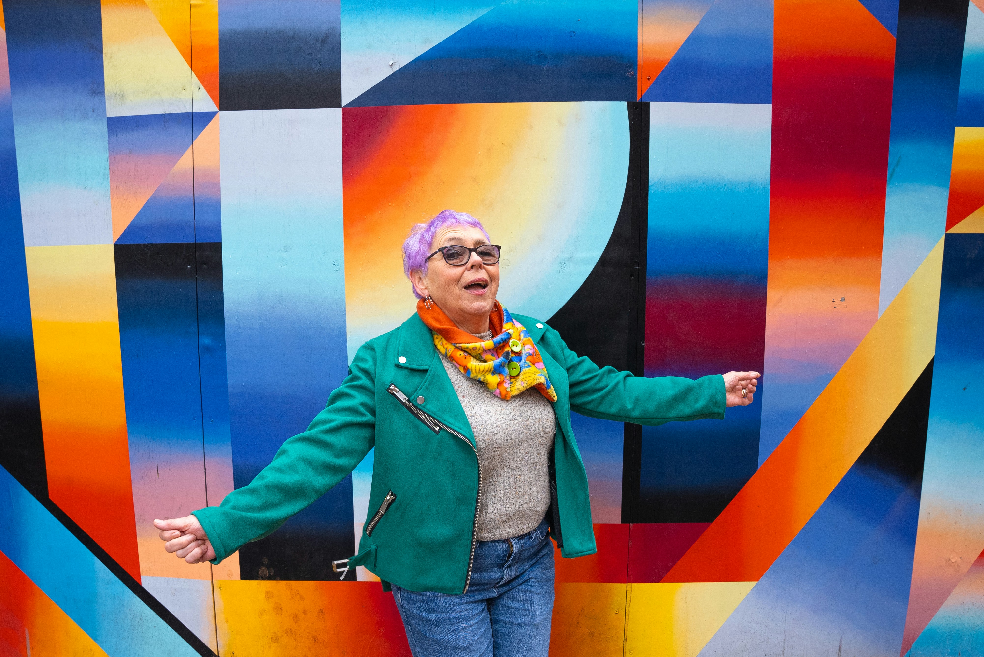 A woman standing in front of a colorful wall photo – Free Portrait ...