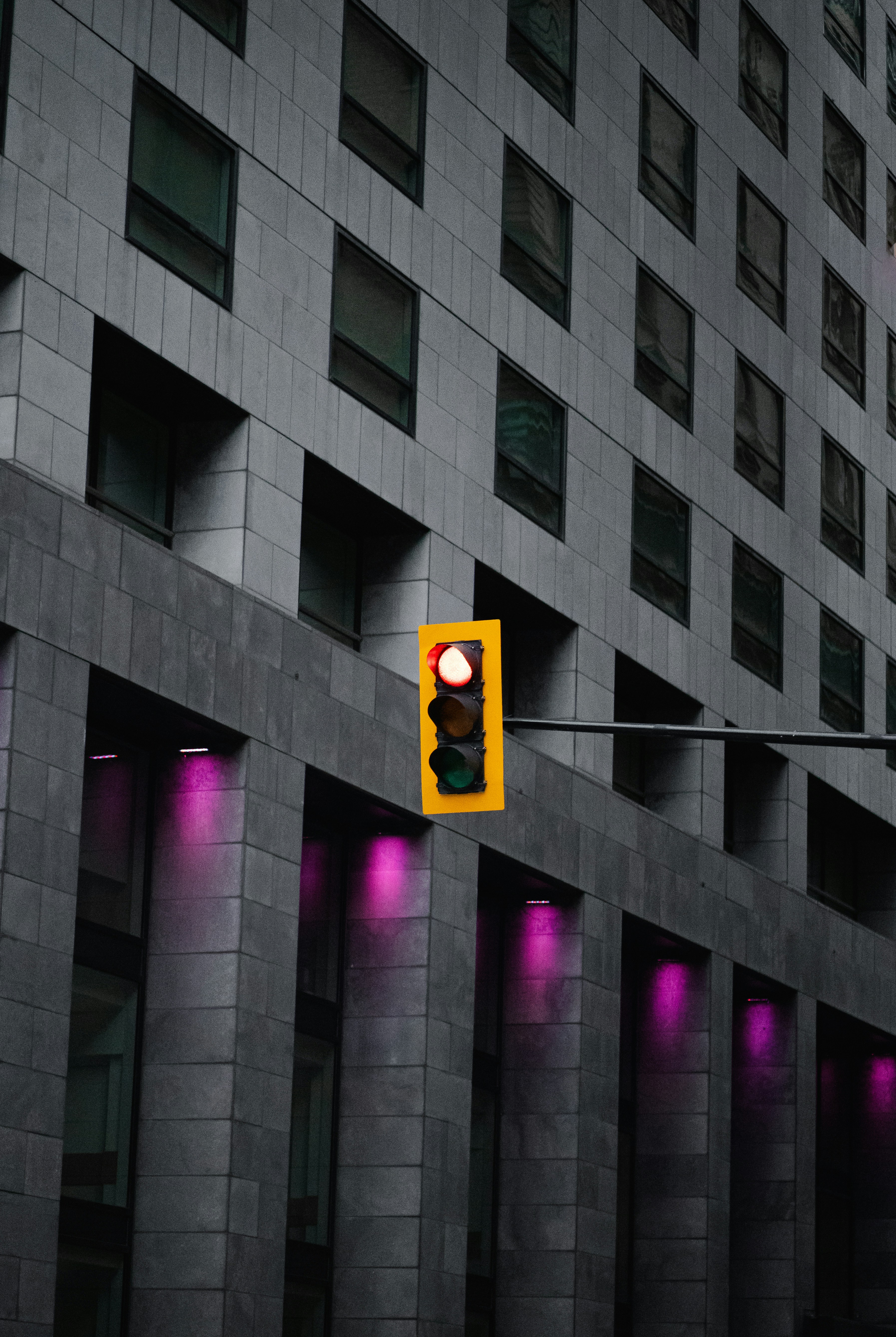 A traffic light hanging from a wire in front of a building photo – Free ...