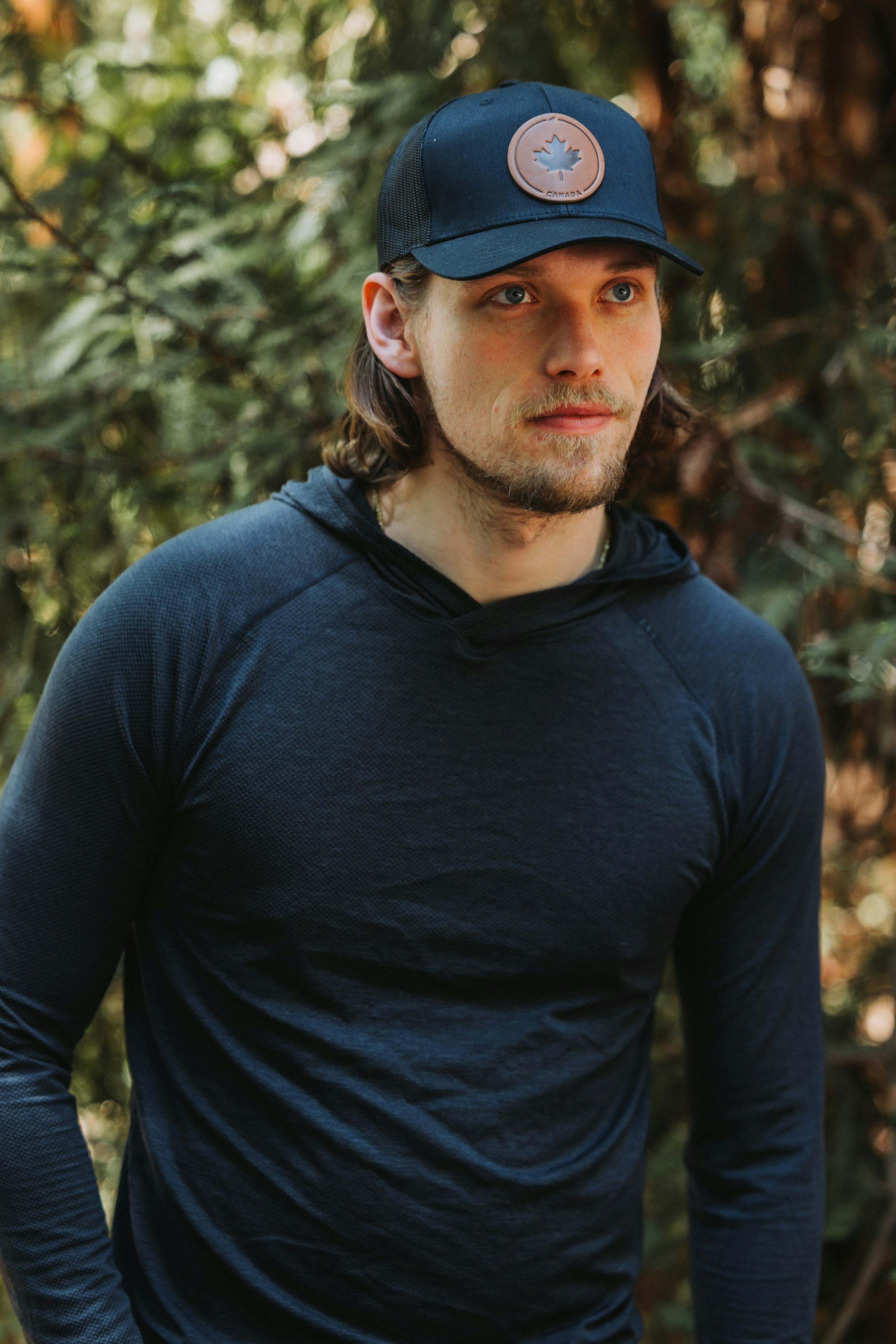 Gaze Among Pines: Portrait in Dappled Forest Light