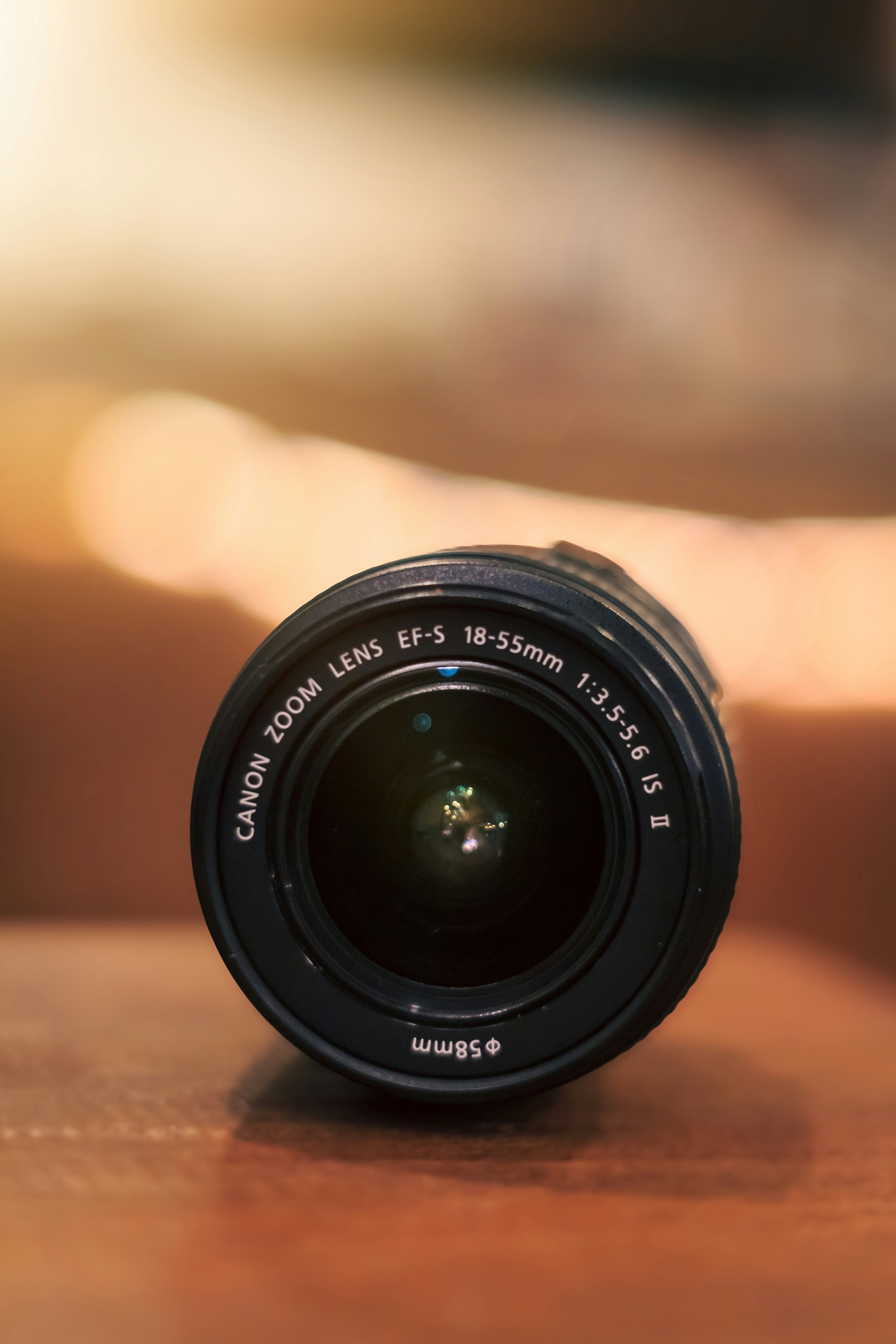 A camera lens sitting on top of a wooden table photo – Free Camera ...