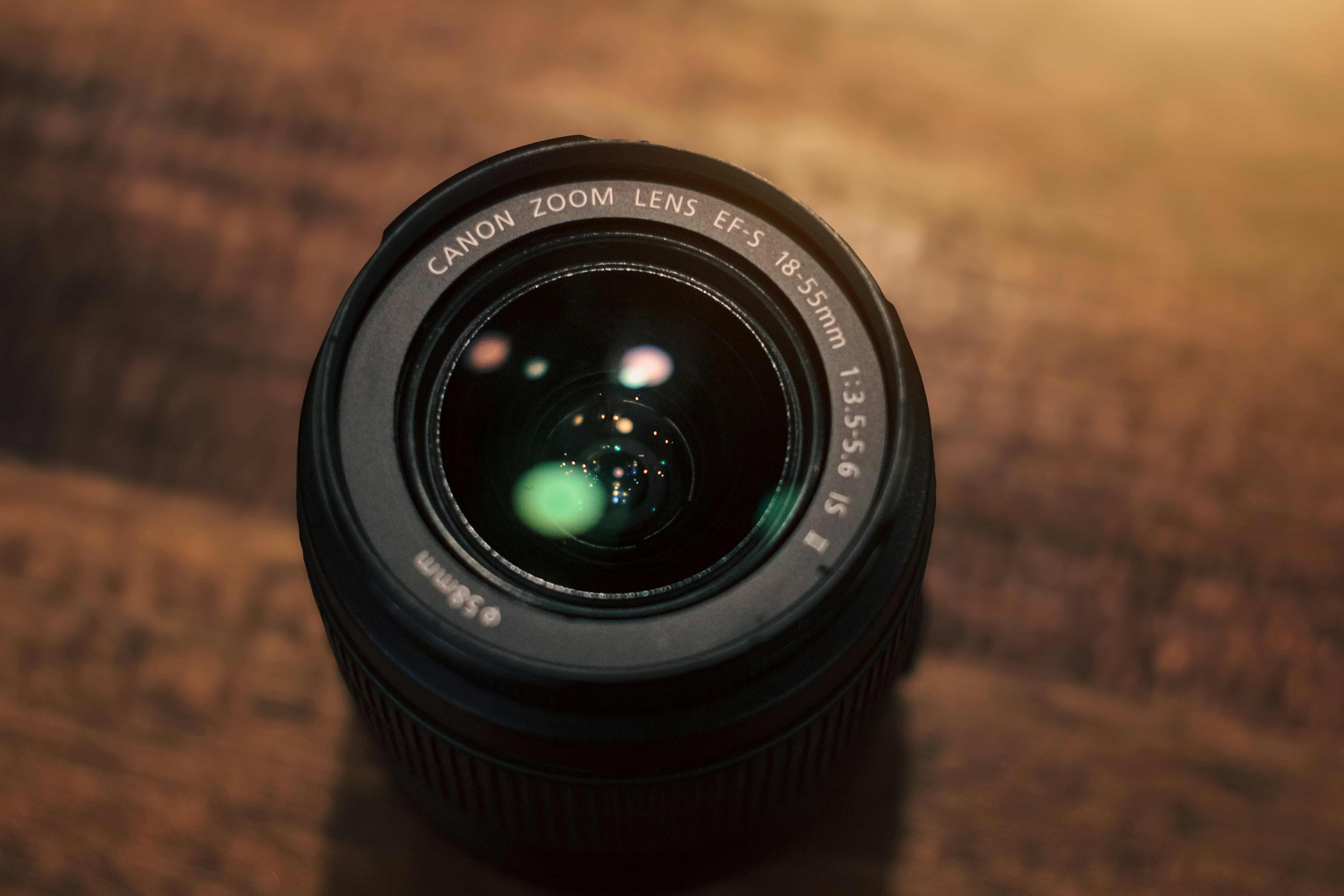 A camera lens sitting on top of a wooden table photo – Free Camera ...