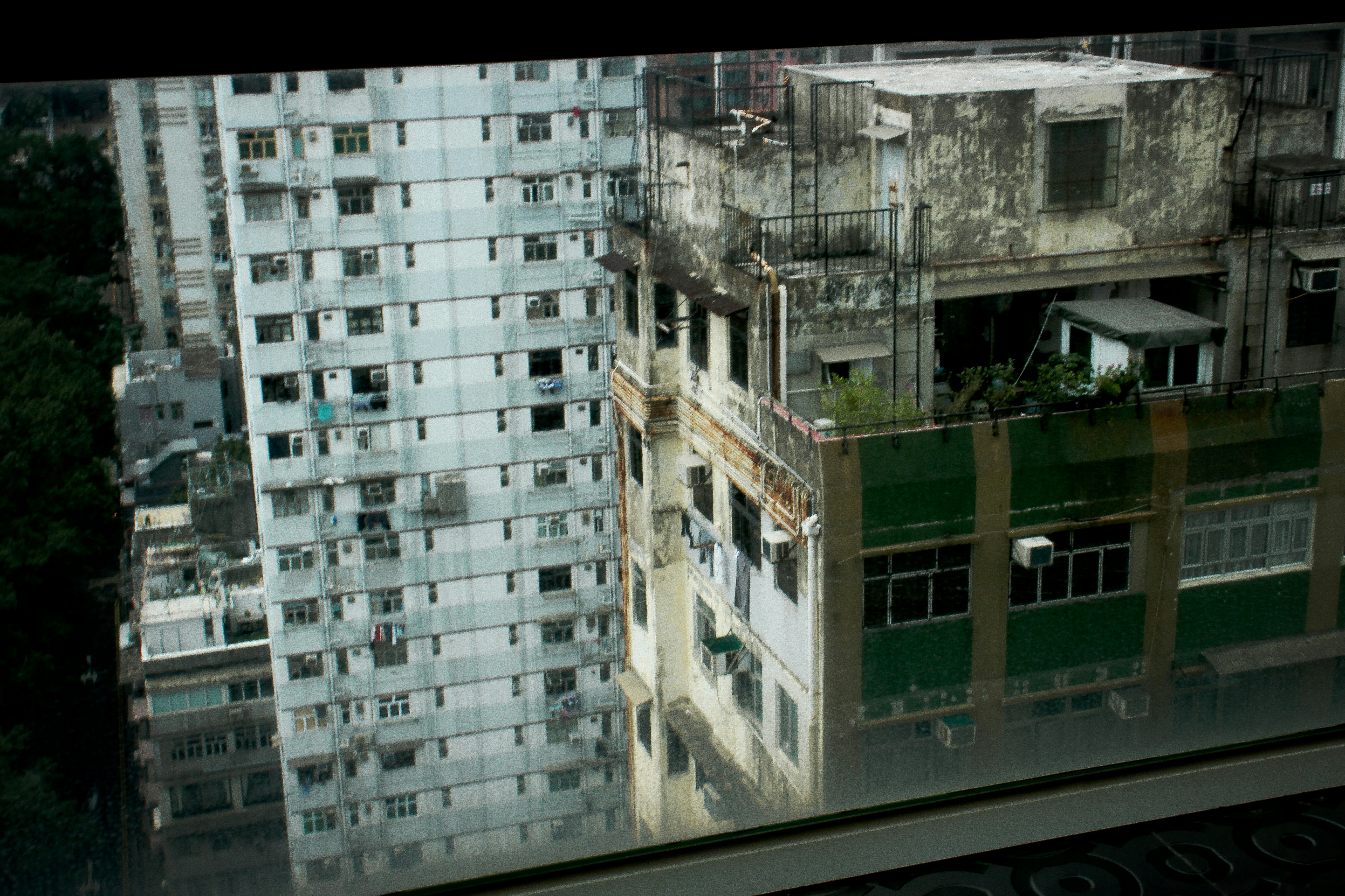 A tall building next to a train track photo – Free Building Image on ...