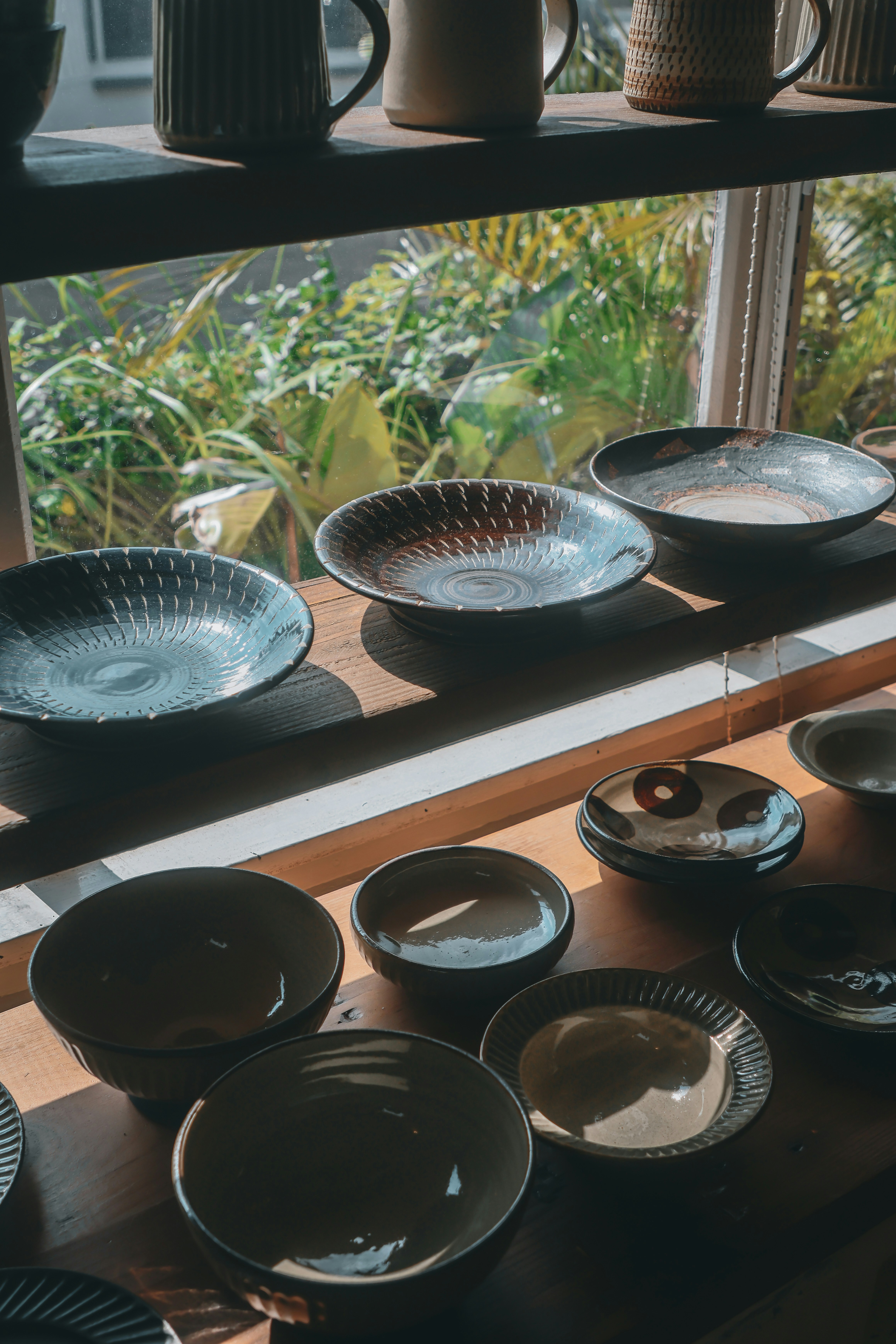 A window sill filled with plates and bowls photo – Free Food Image on ...