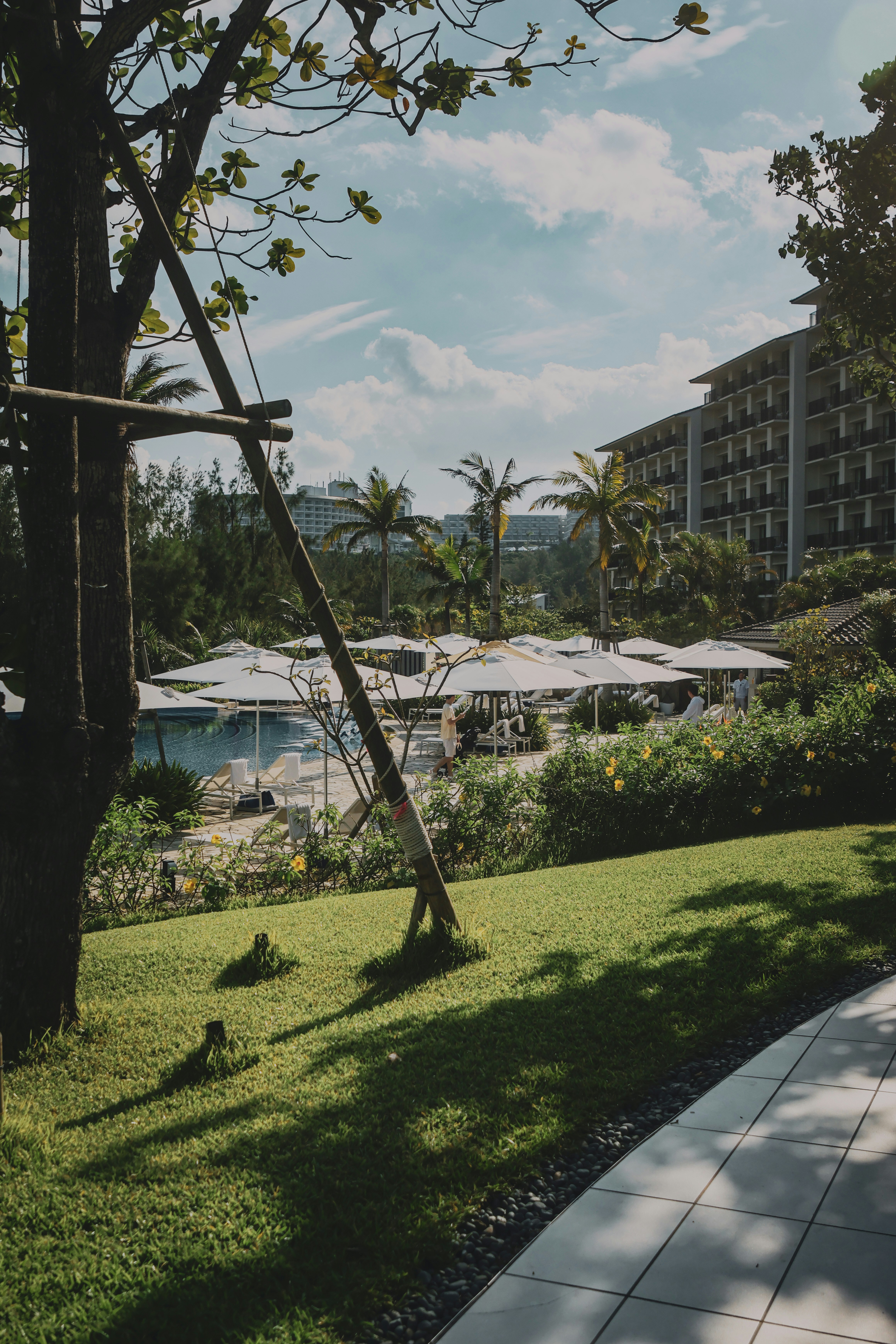 Resort Oasis: Poolside Calm Beneath Dappled Shade