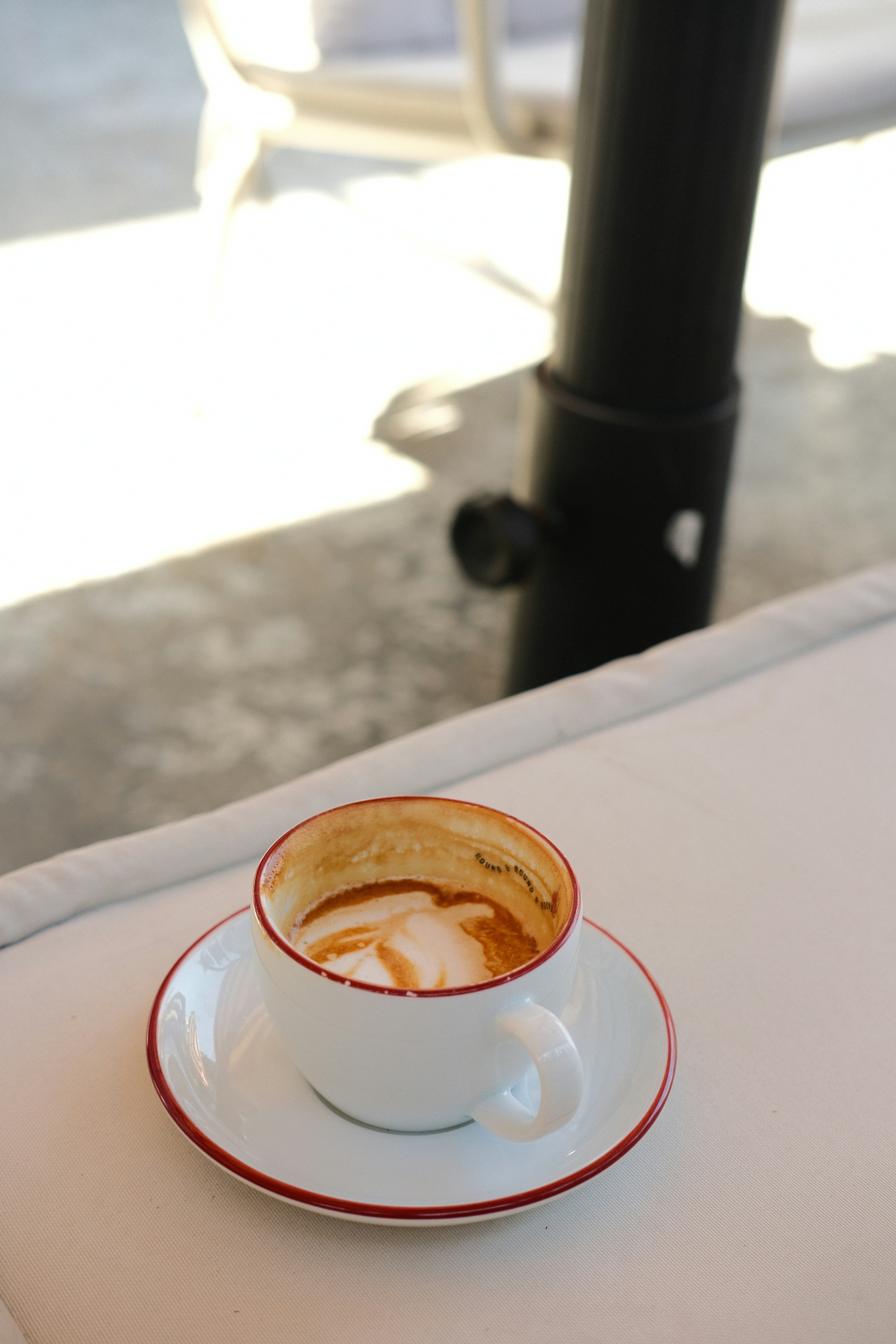 Sunlit Espresso Moment: Latte Art on a Quiet Café Table