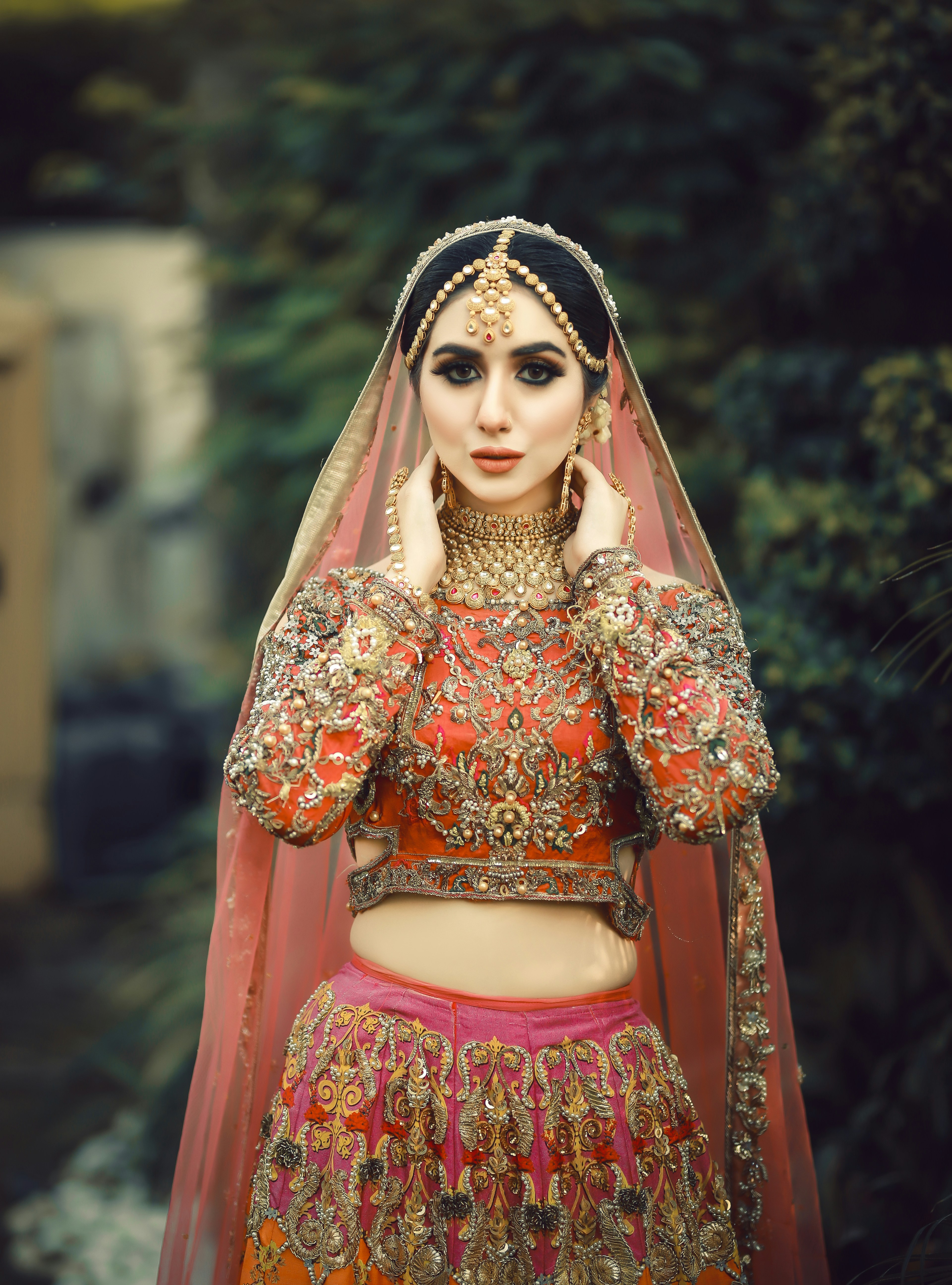 A woman in a red and gold bridal outfit photo – Free Naeem ad studios Image on Unsplash