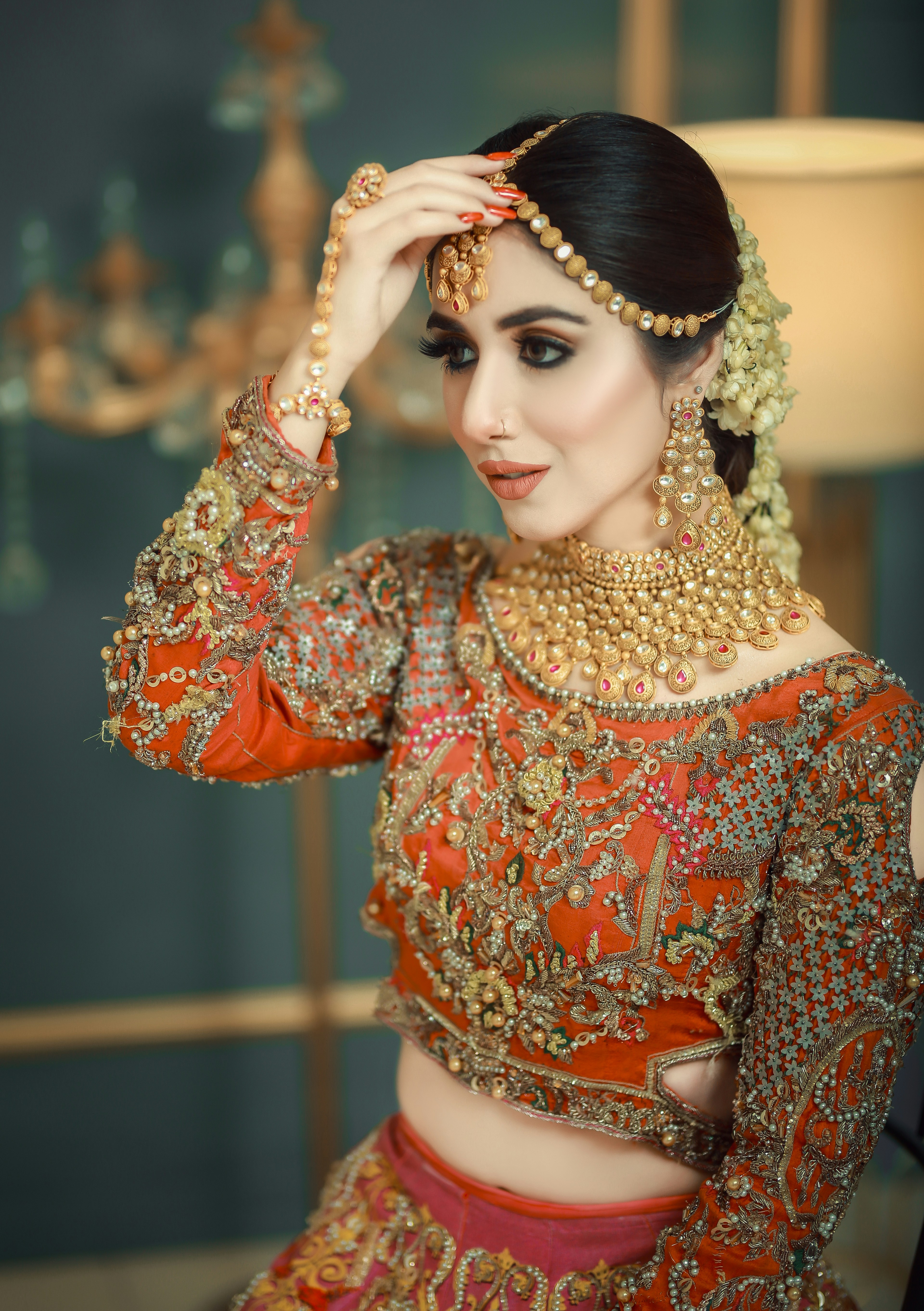 A woman in a red and gold outfit photo – Free Naeem ad studios Image on Unsplash