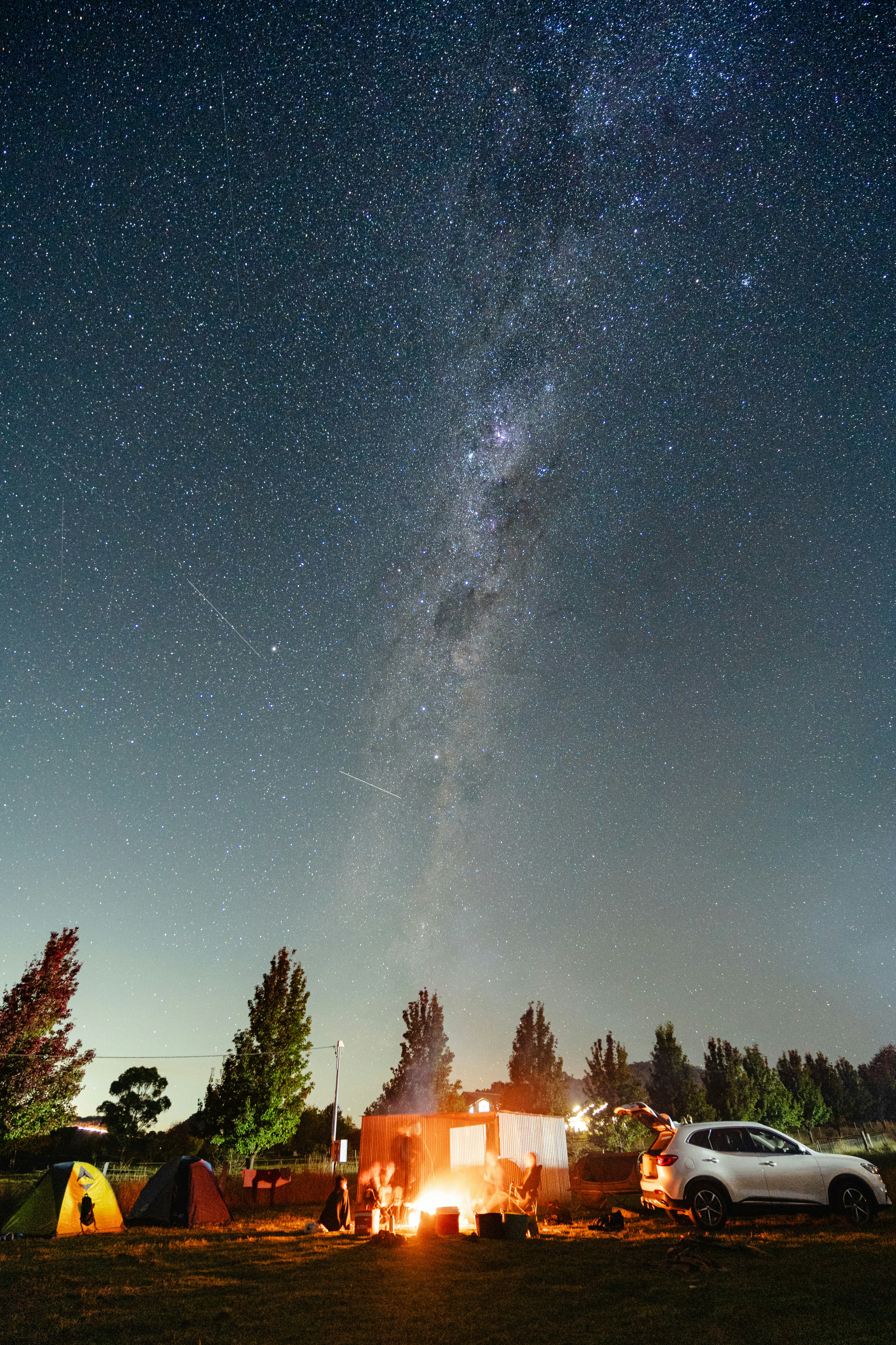 Milky Way Core Looms Over Lantern-lit Campsite