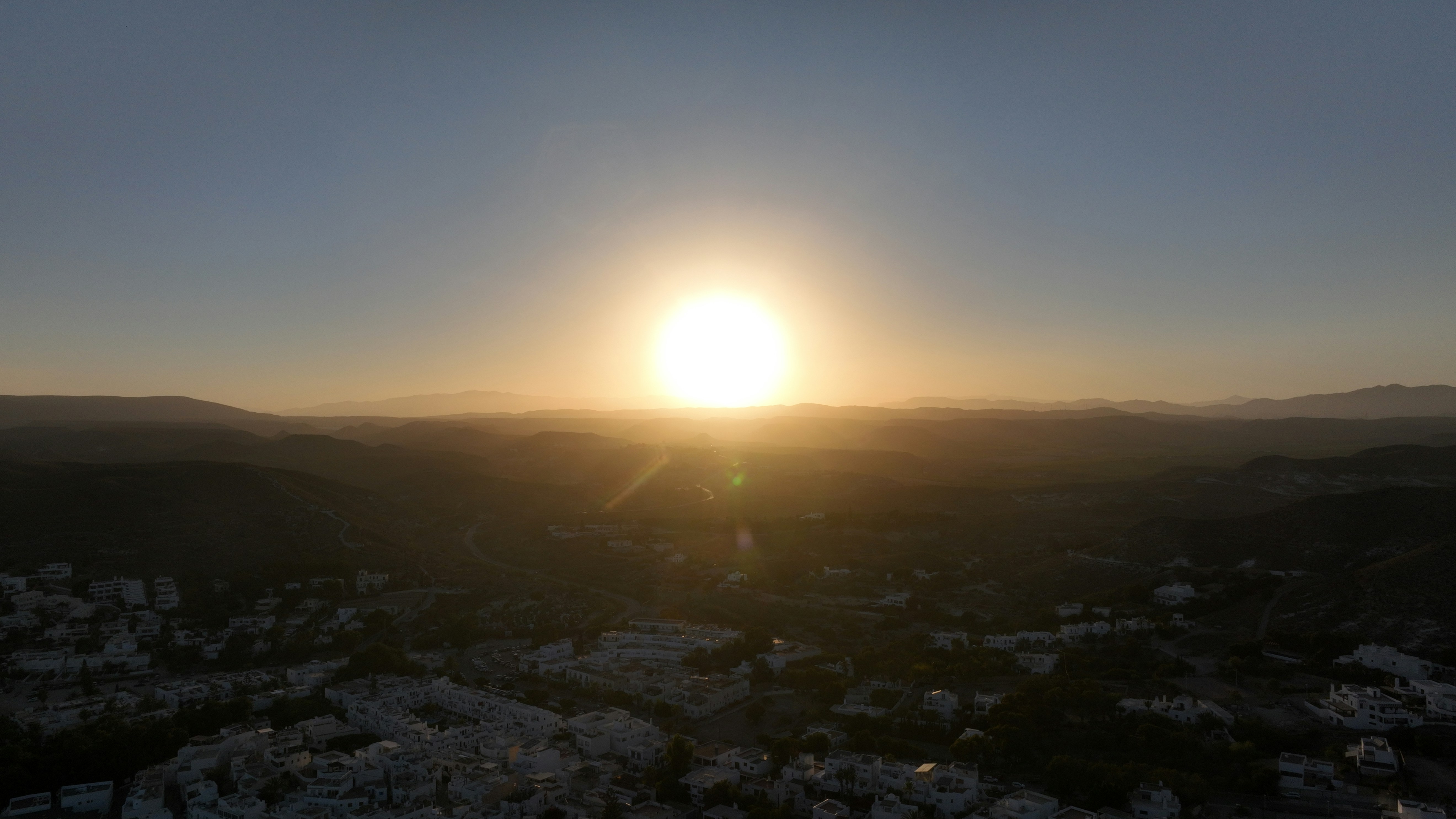 Horizon of Quiet Gold: Sunset Over a Snow-Dusted Valley
