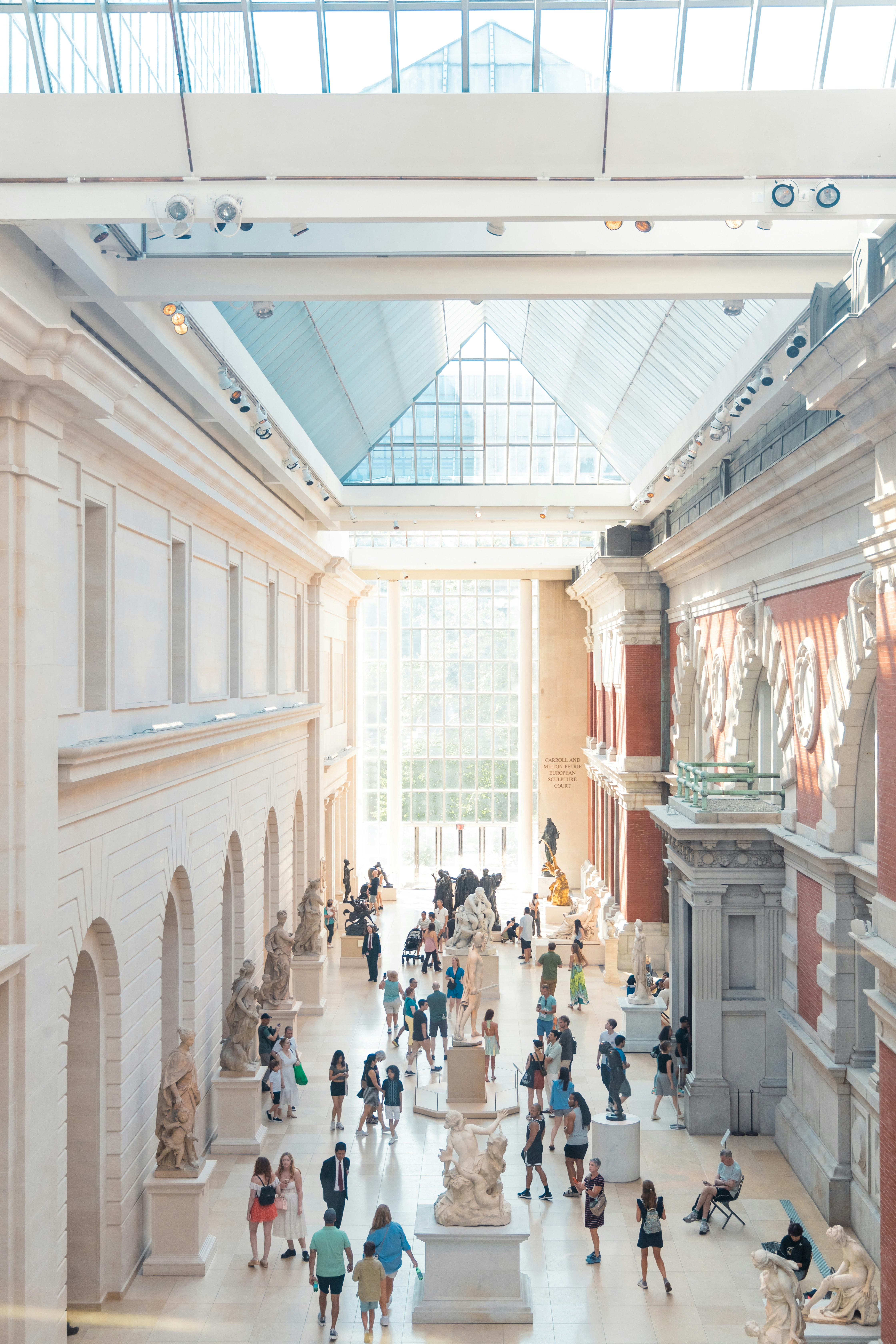 A group of people walking around a museum photo – Free Building Image ...