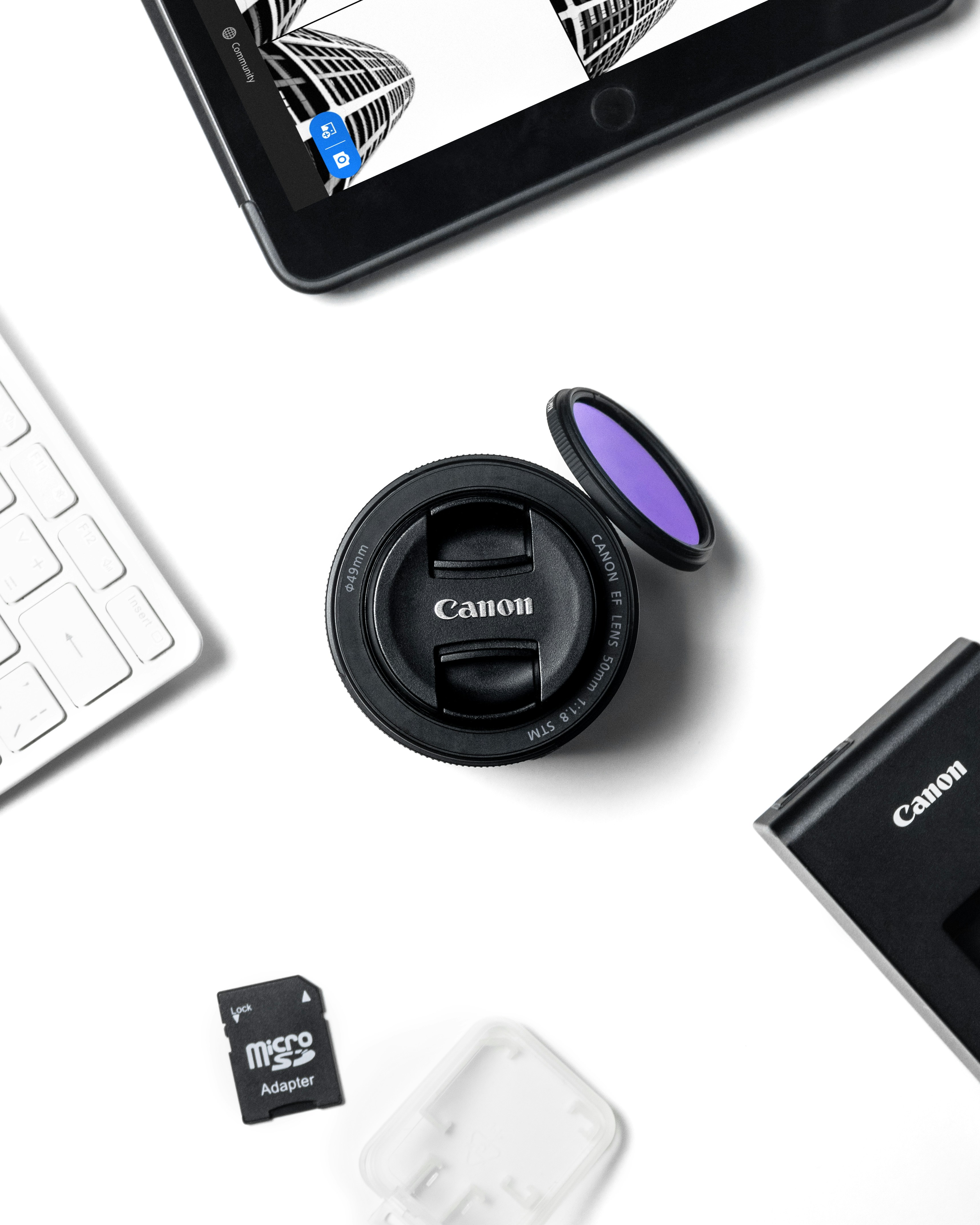 Centered Canon Kit: A Minimal Flat-Lay of Lens Cap, Filter, and SD Card