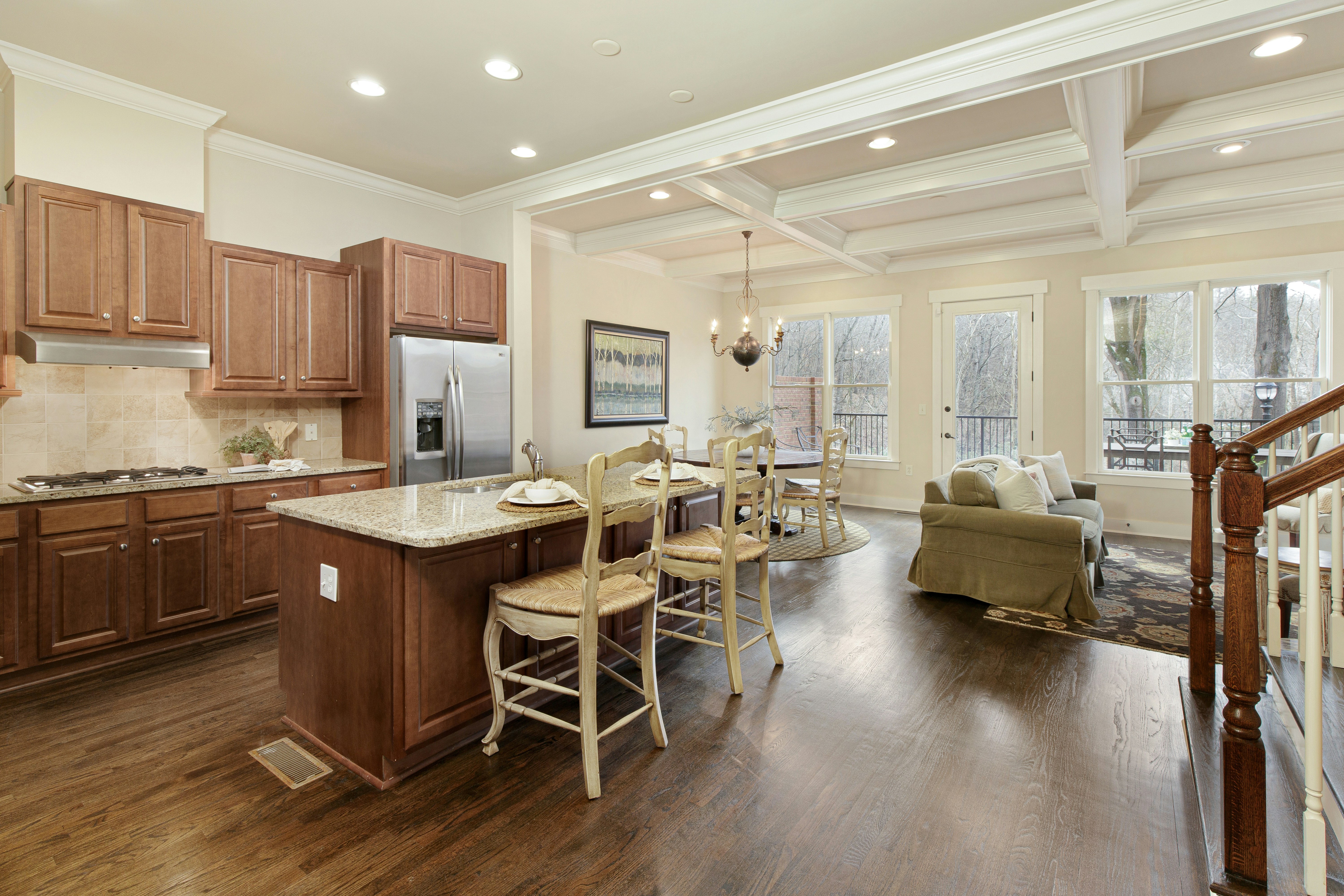 A large open kitchen and living room with hardwood floors photo – Free ...