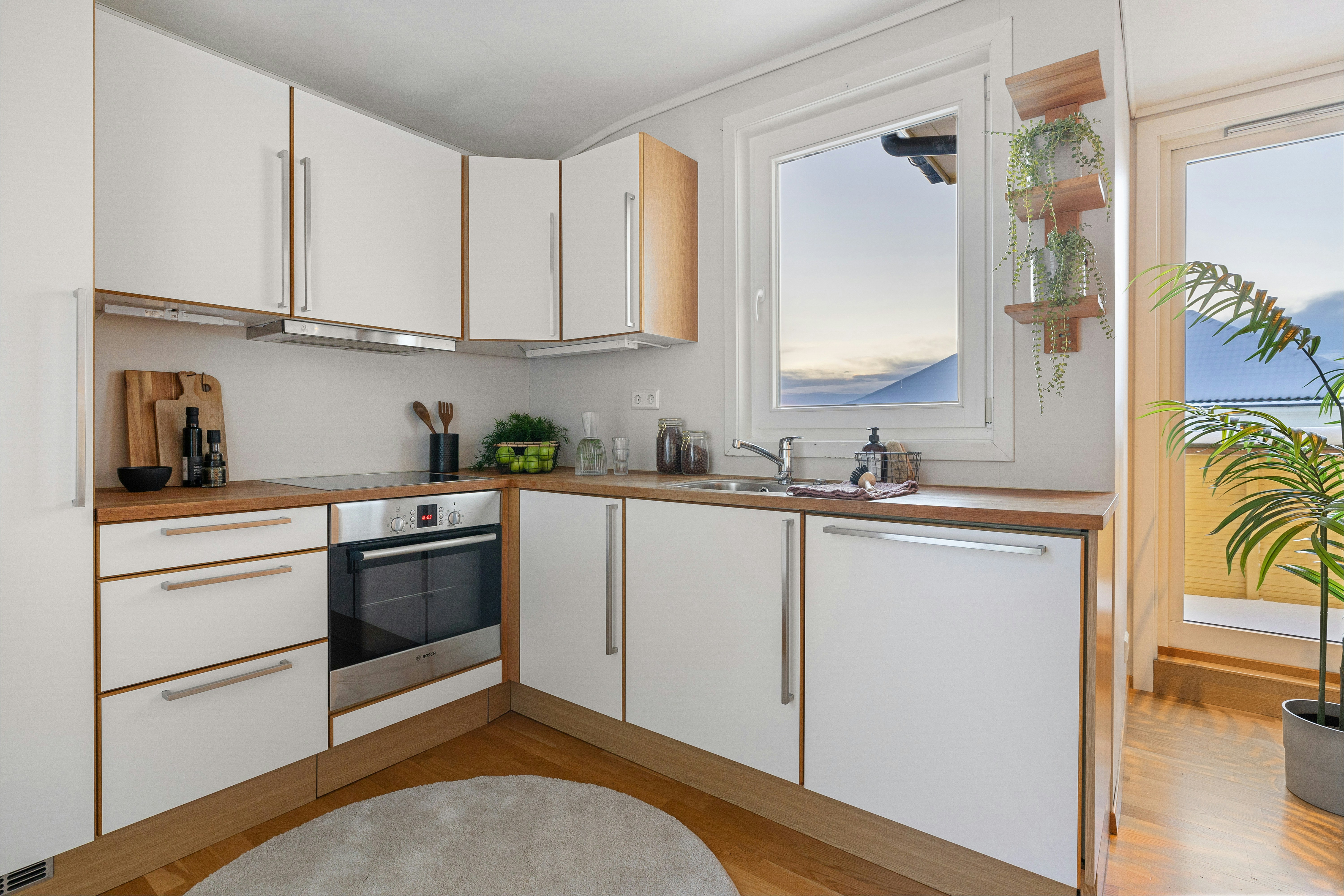 Bright U‑Shaped Kitchen with Central Island and Large Window