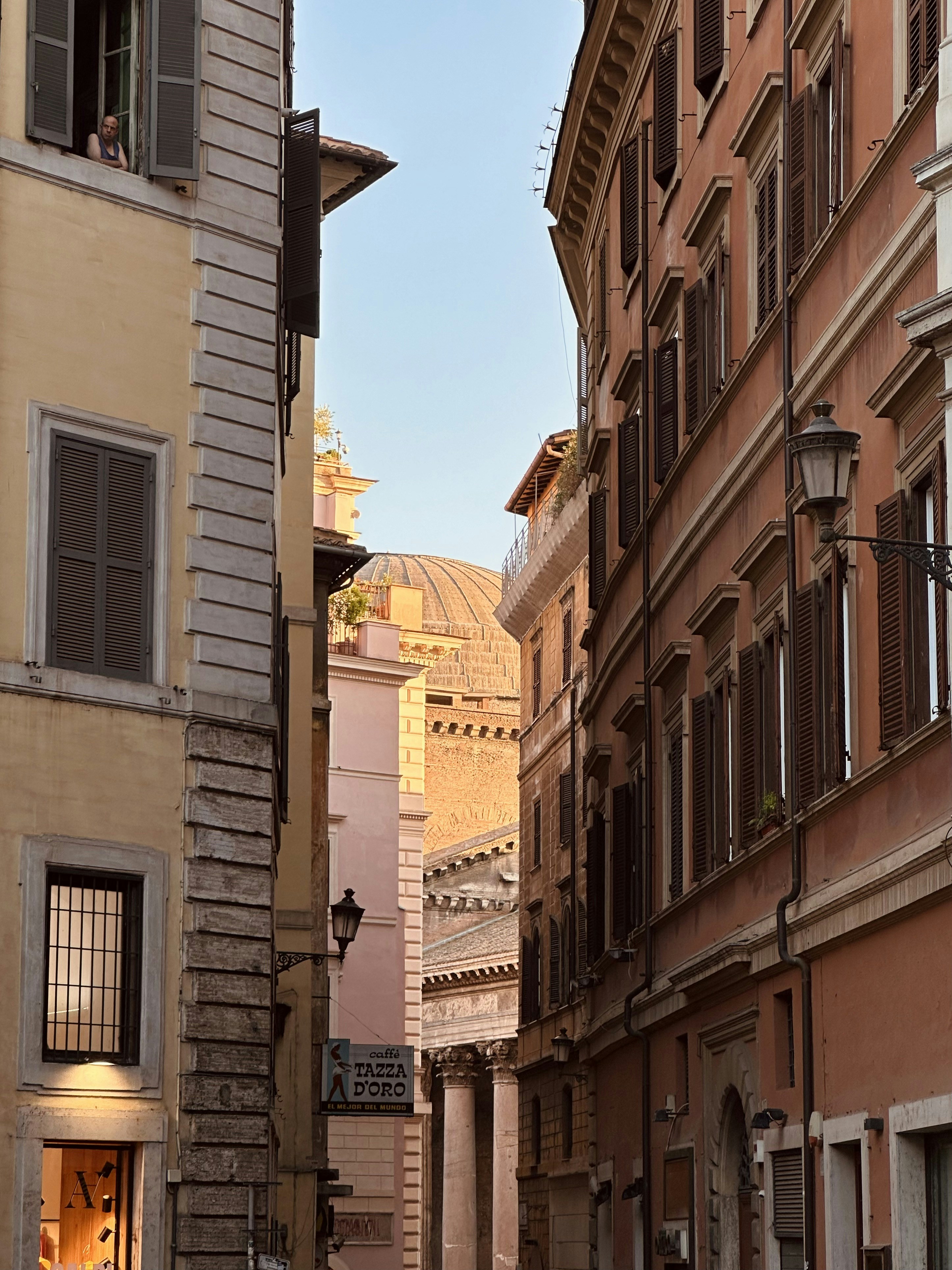 A narrow city street with buildings on both sides photo – Free Pantheon ...