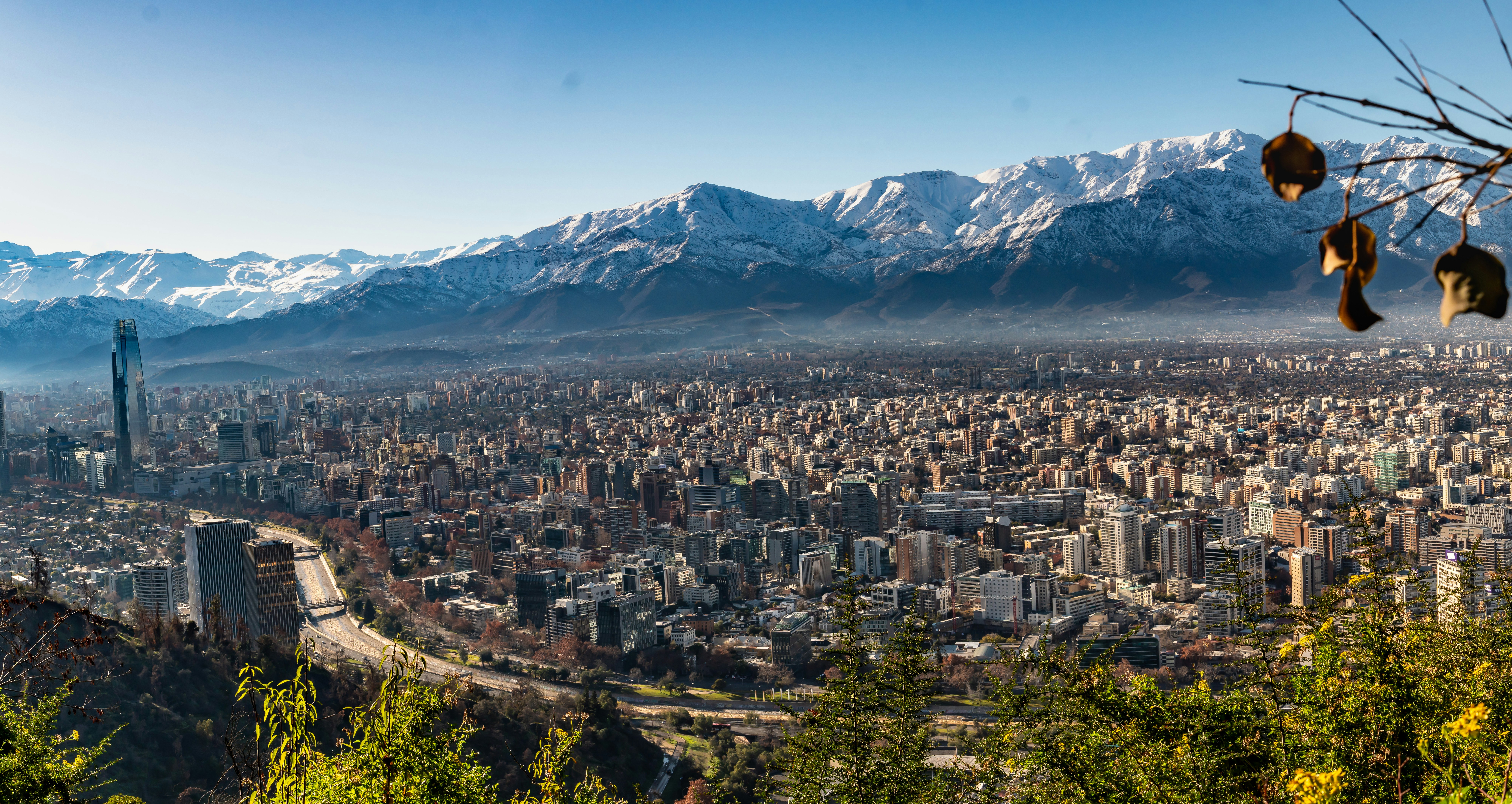 Sweeping view of Santiago with the Andes mountains in the background on a clear day.