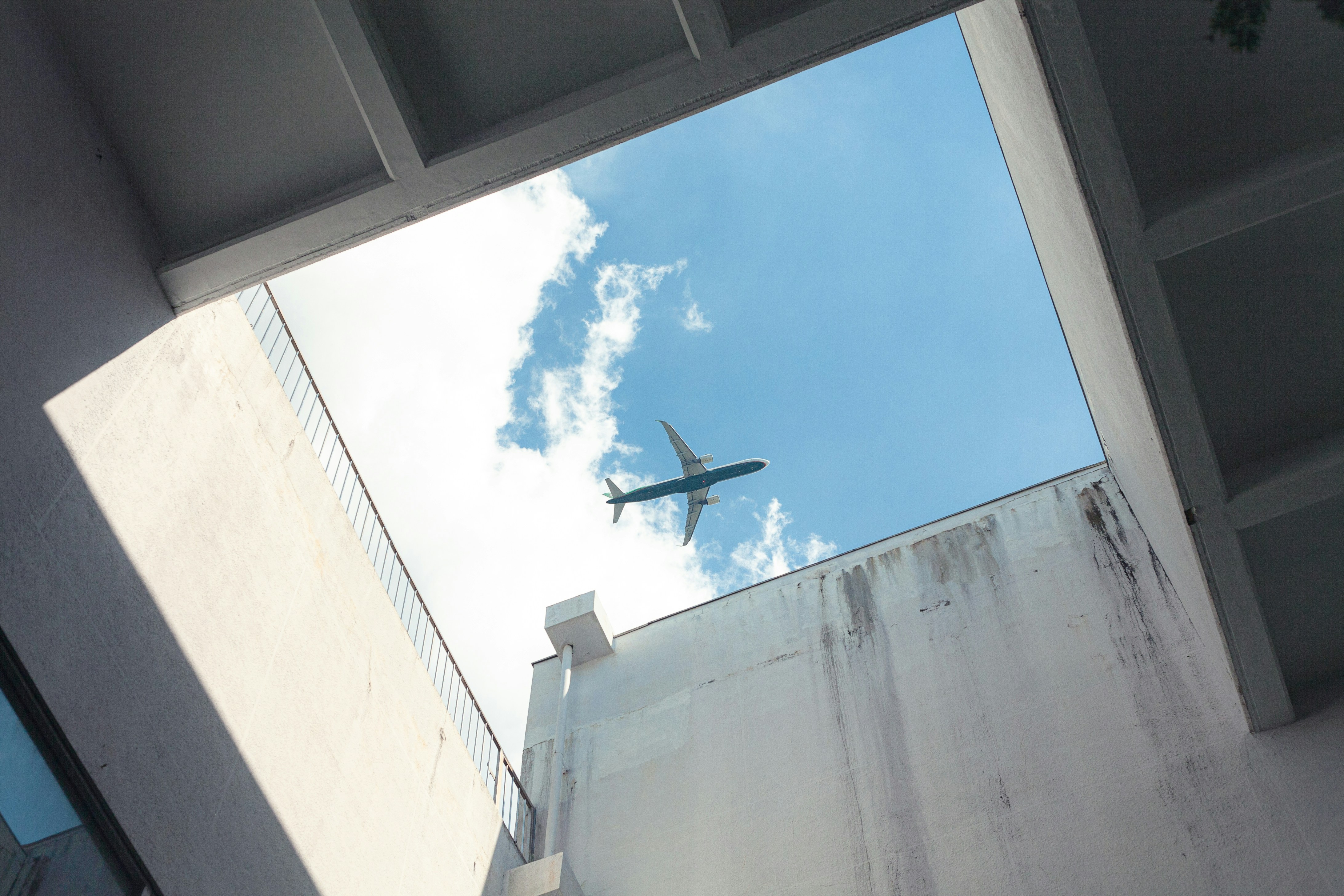Jet Over the Atrium Sky: An Airliner Traverses the Urban Skyway
