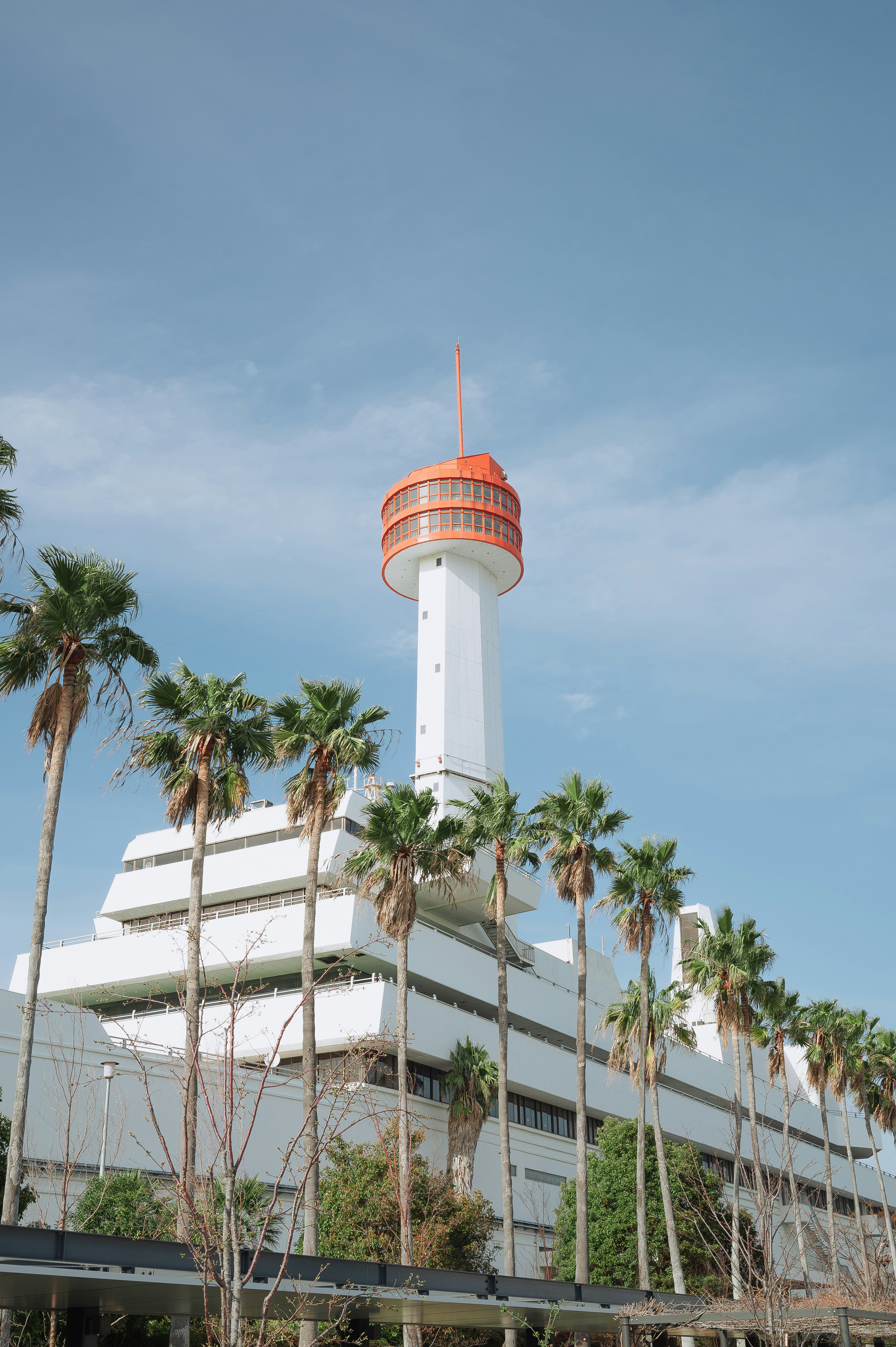 A large building with a tower and palm trees photo – Free Tokyo Image ...
