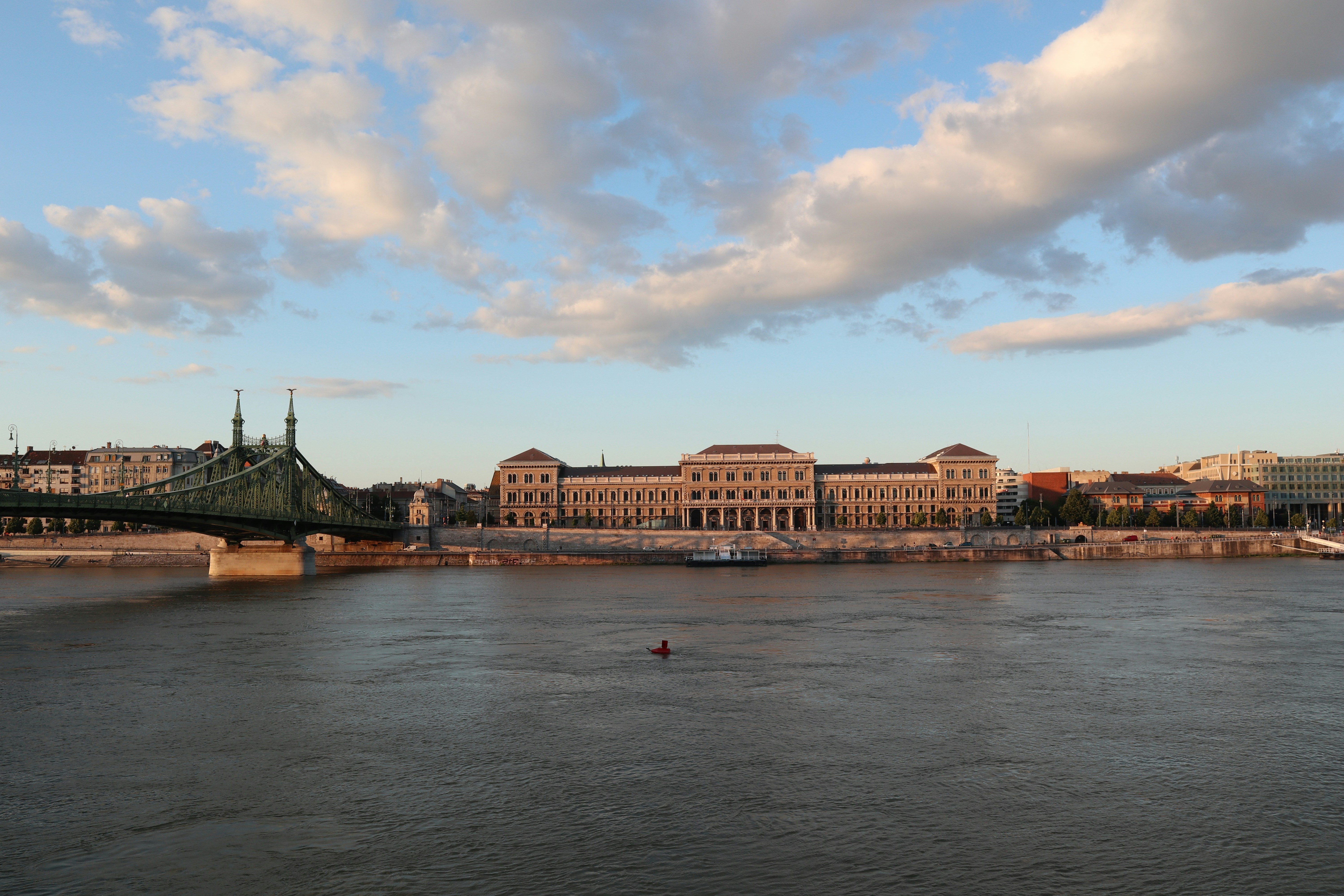 Danube Dusk: Green Suspension Bridge Framing a Timeless Riverside