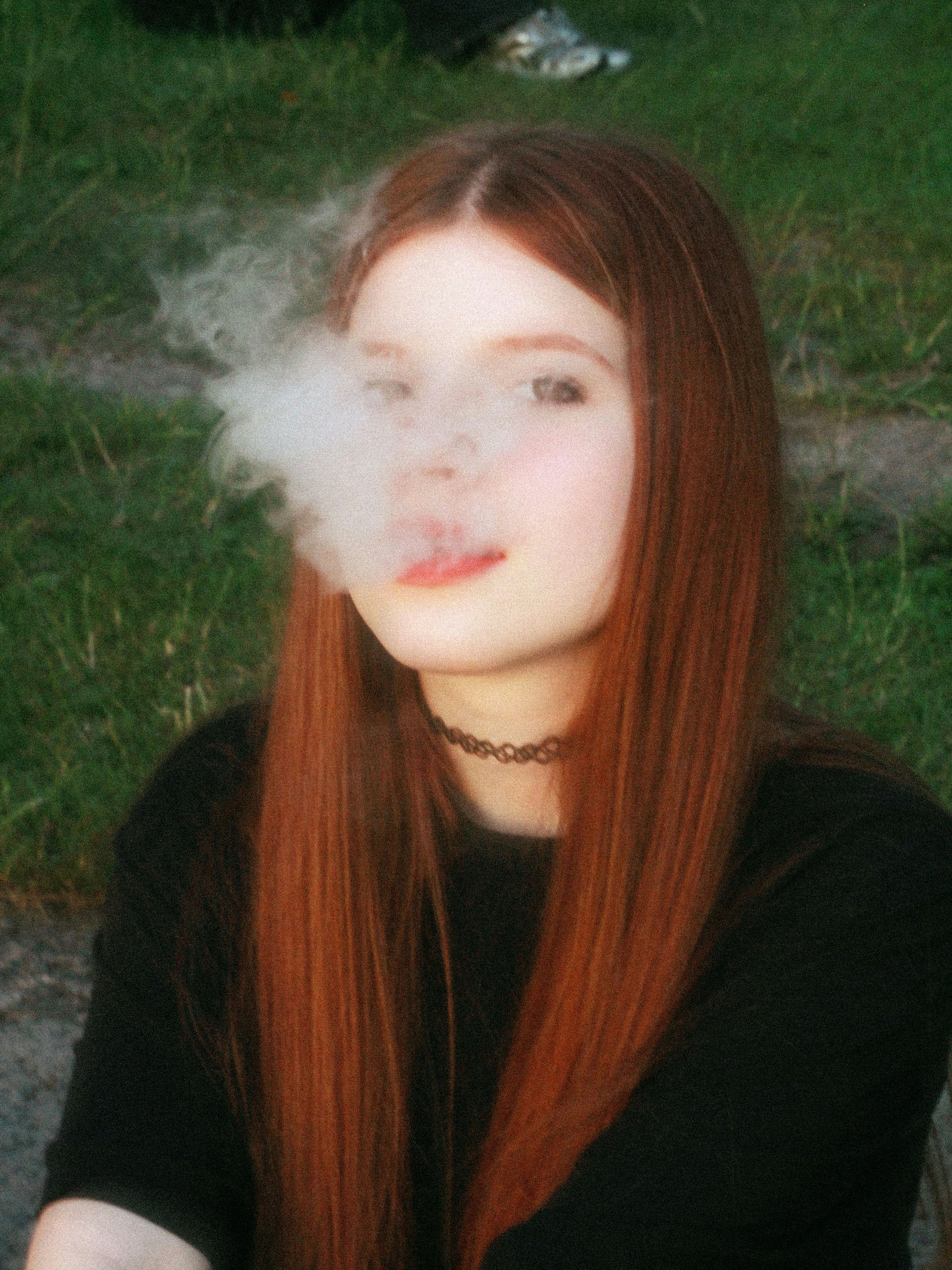 A woman with long red hair smoking a cigarette photo – Free Ukraine ...
