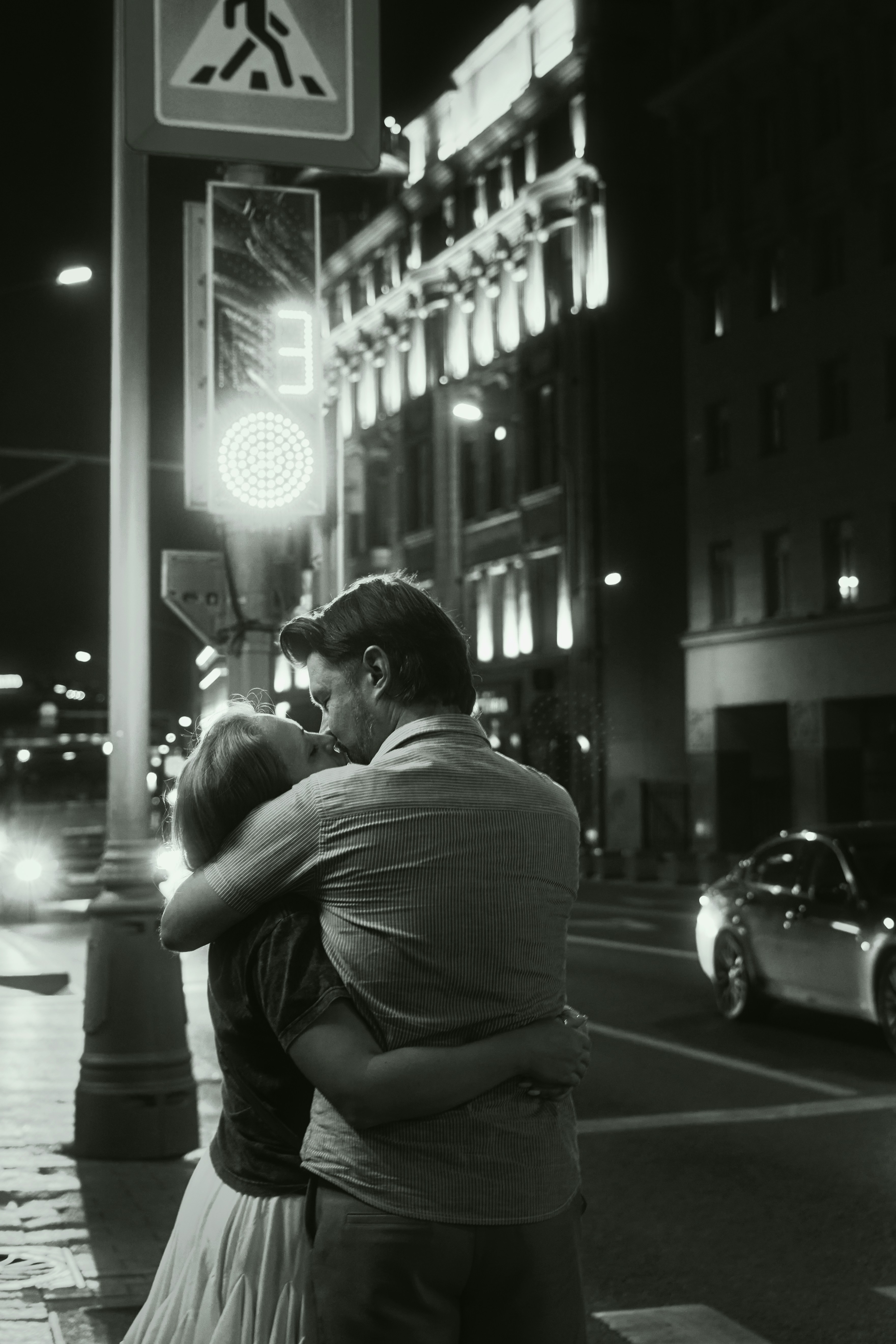 Crosswalk Reverie: An Intimate Night Moment Under City Lights