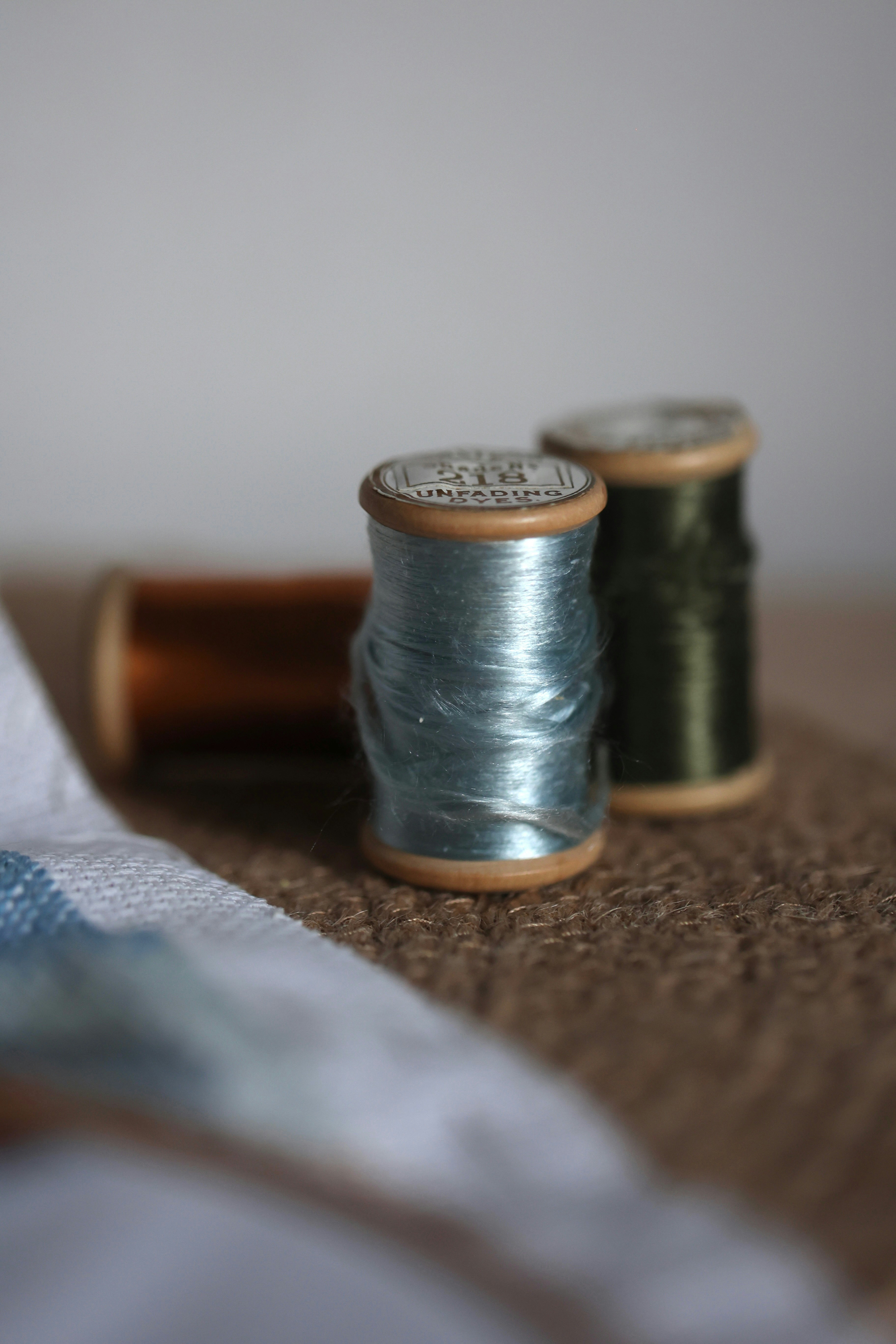 Two spools of thread sitting on a table photo – Free Sewing Image on ...