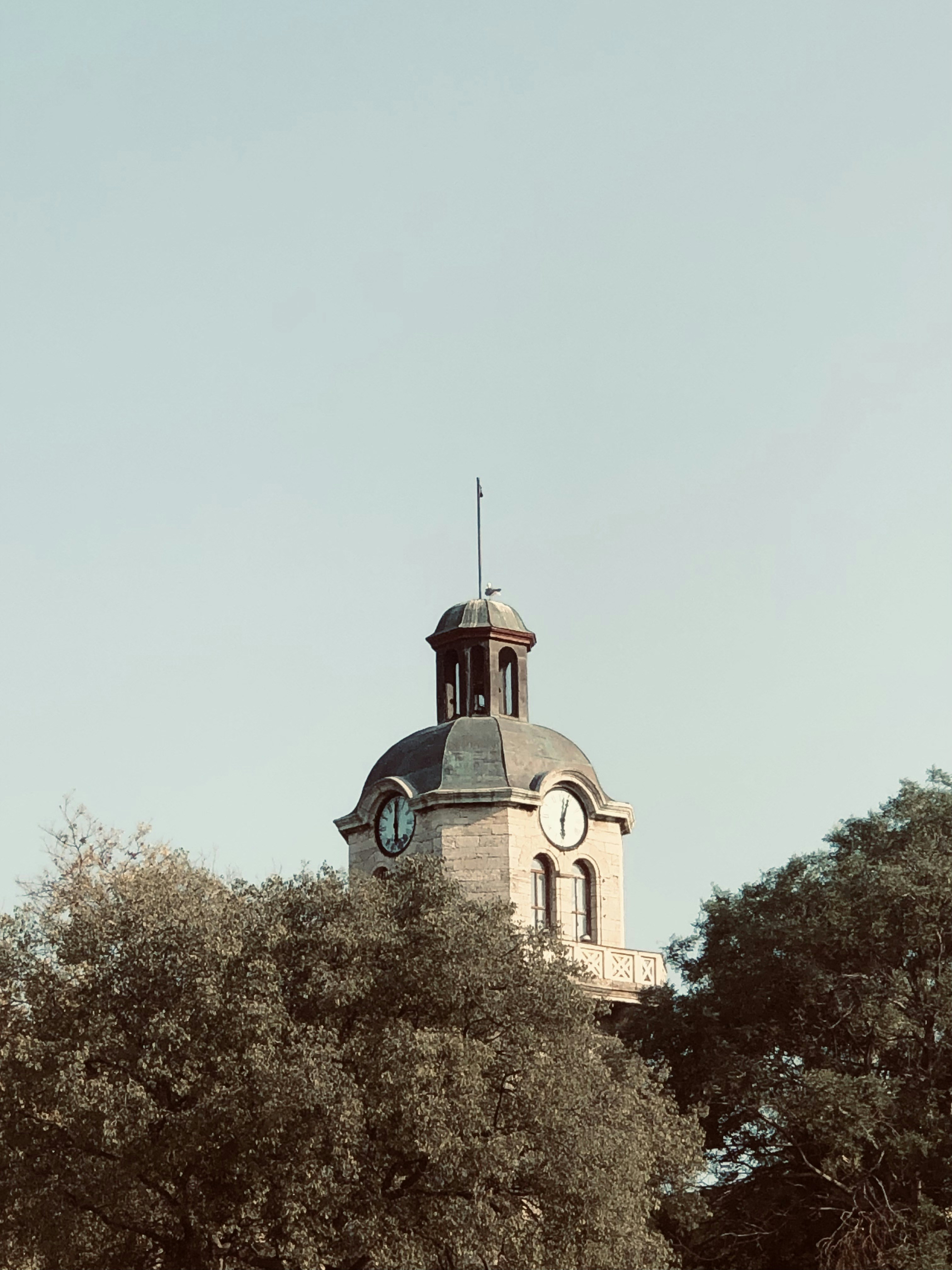 A tall clock tower with a clock on each of it's sides photo – Free ...
