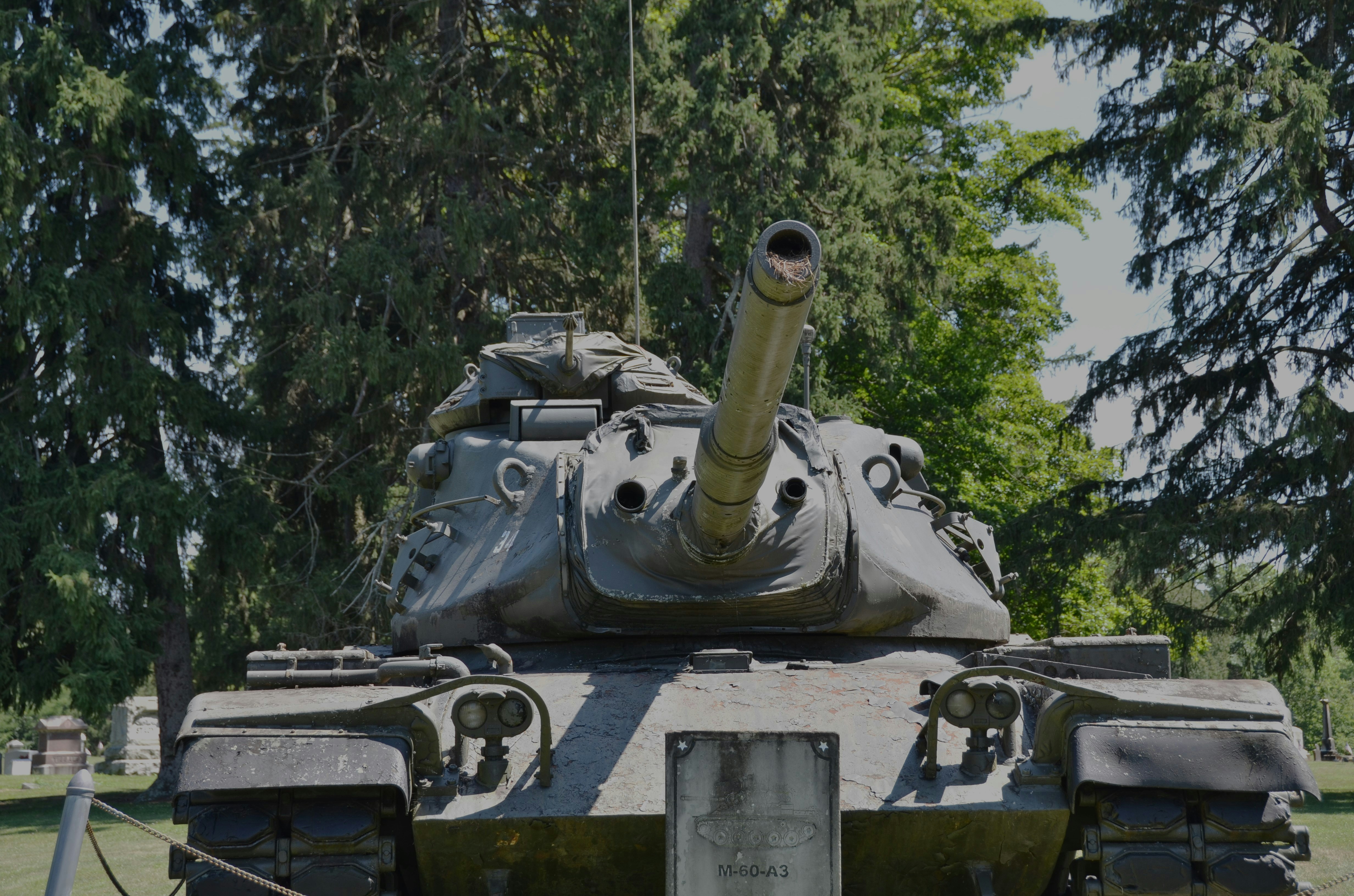 A tank sitting in the middle of a park photo – Free Armored Image on ...