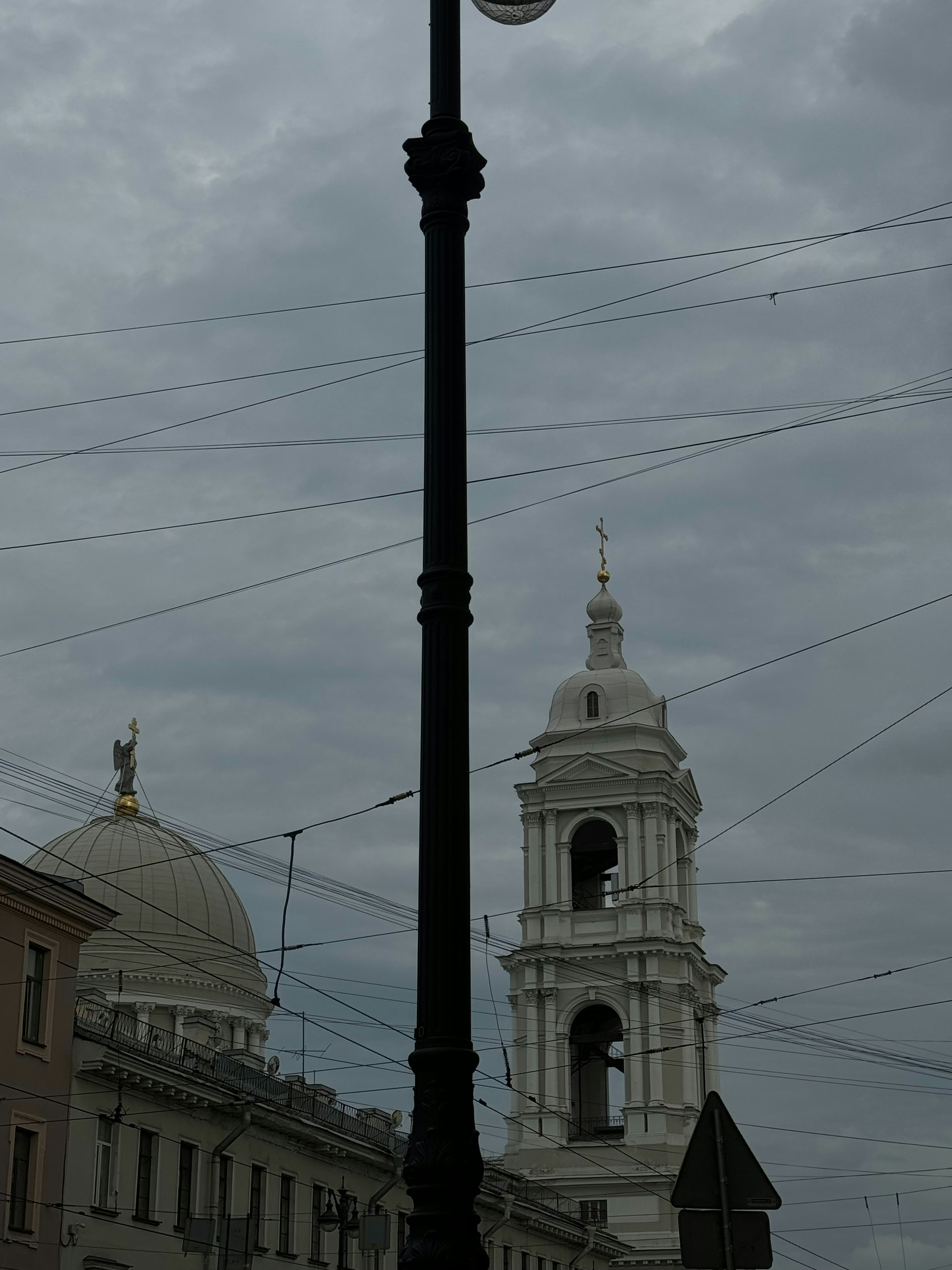 Urban Geometry: White Bell Tower Framed by Overhead Cables