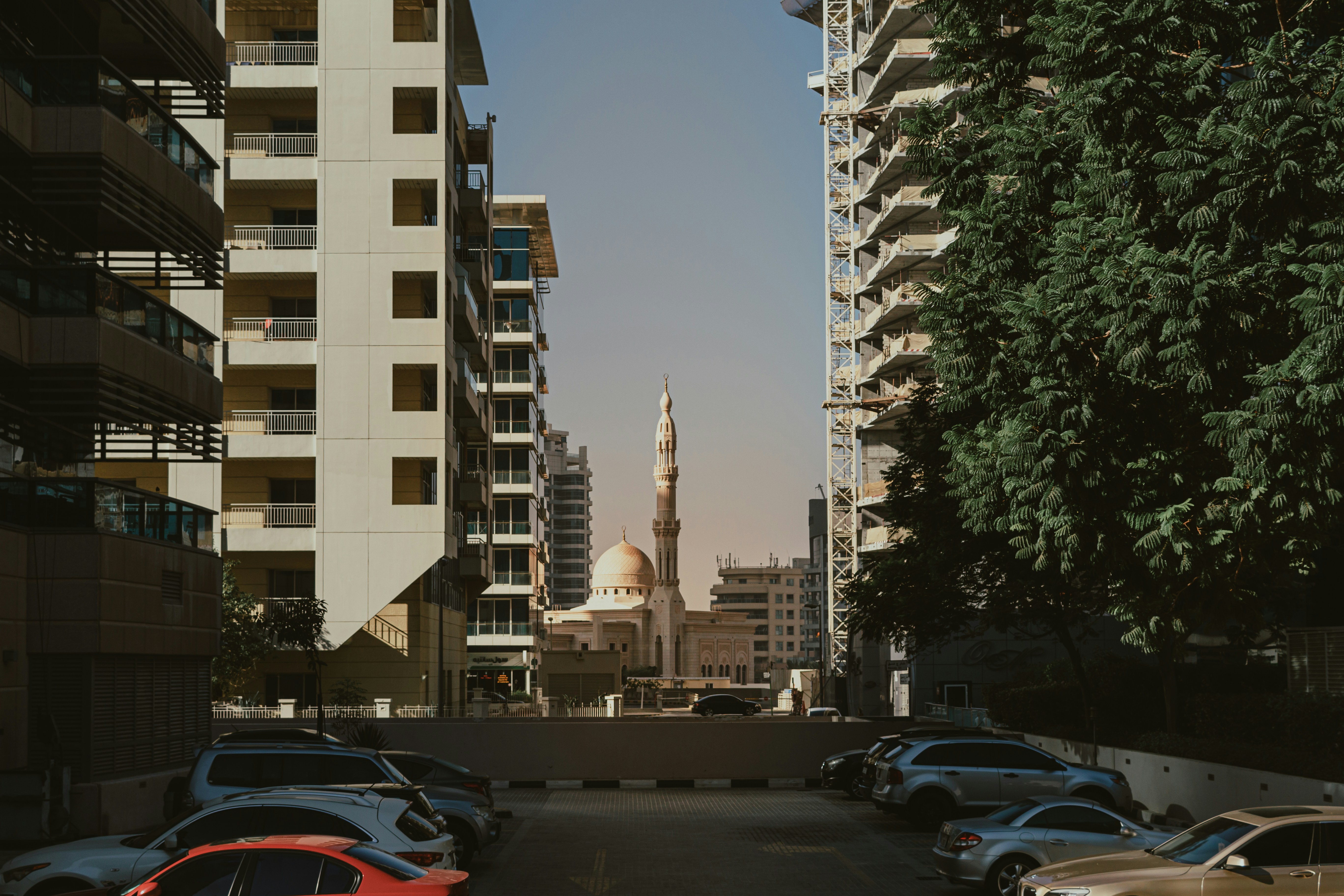 Distant Minaret Rising Above the Urban Street Corridor