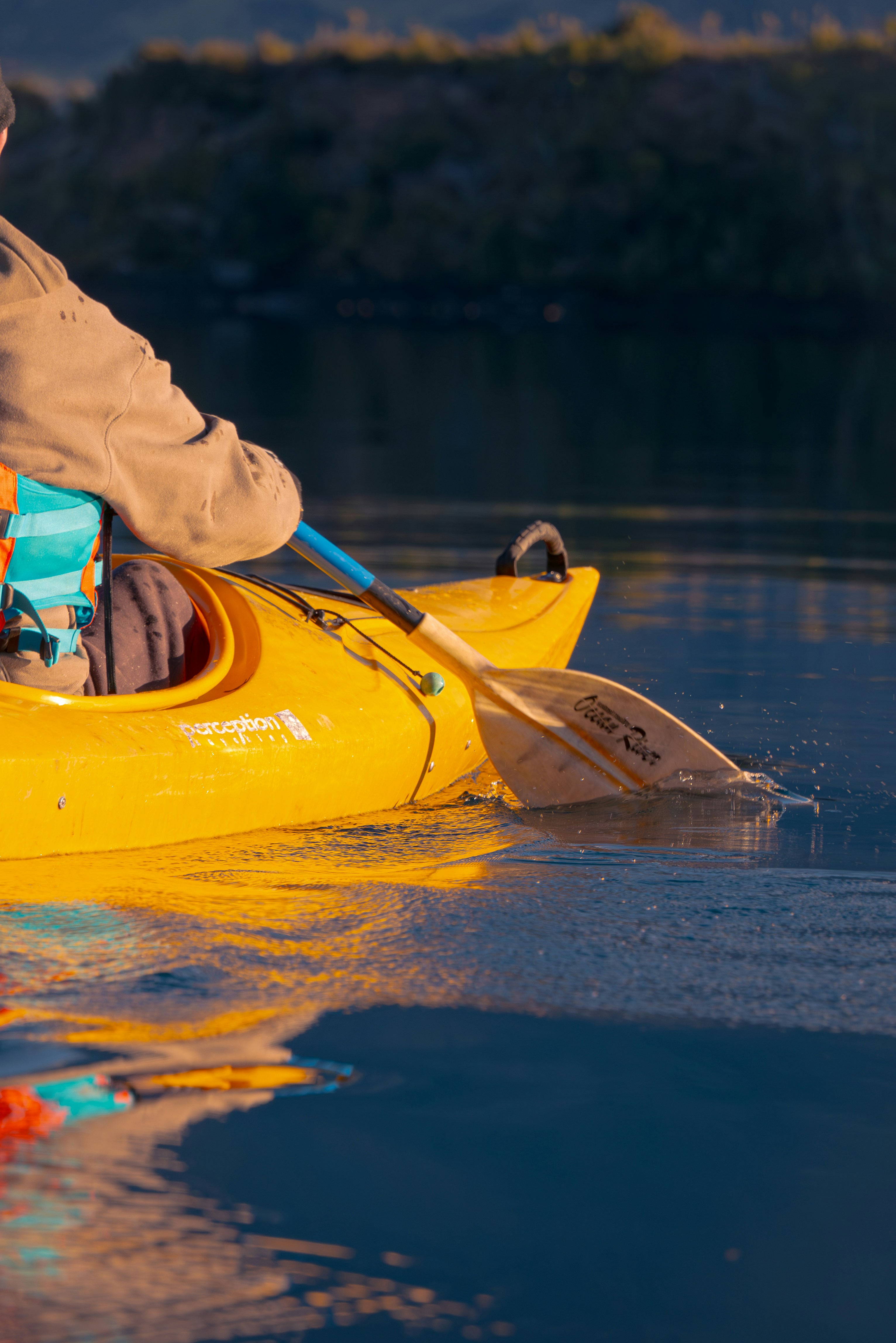 A man riding a yellow kayak on top of a lake photo – Free Winter Image ...