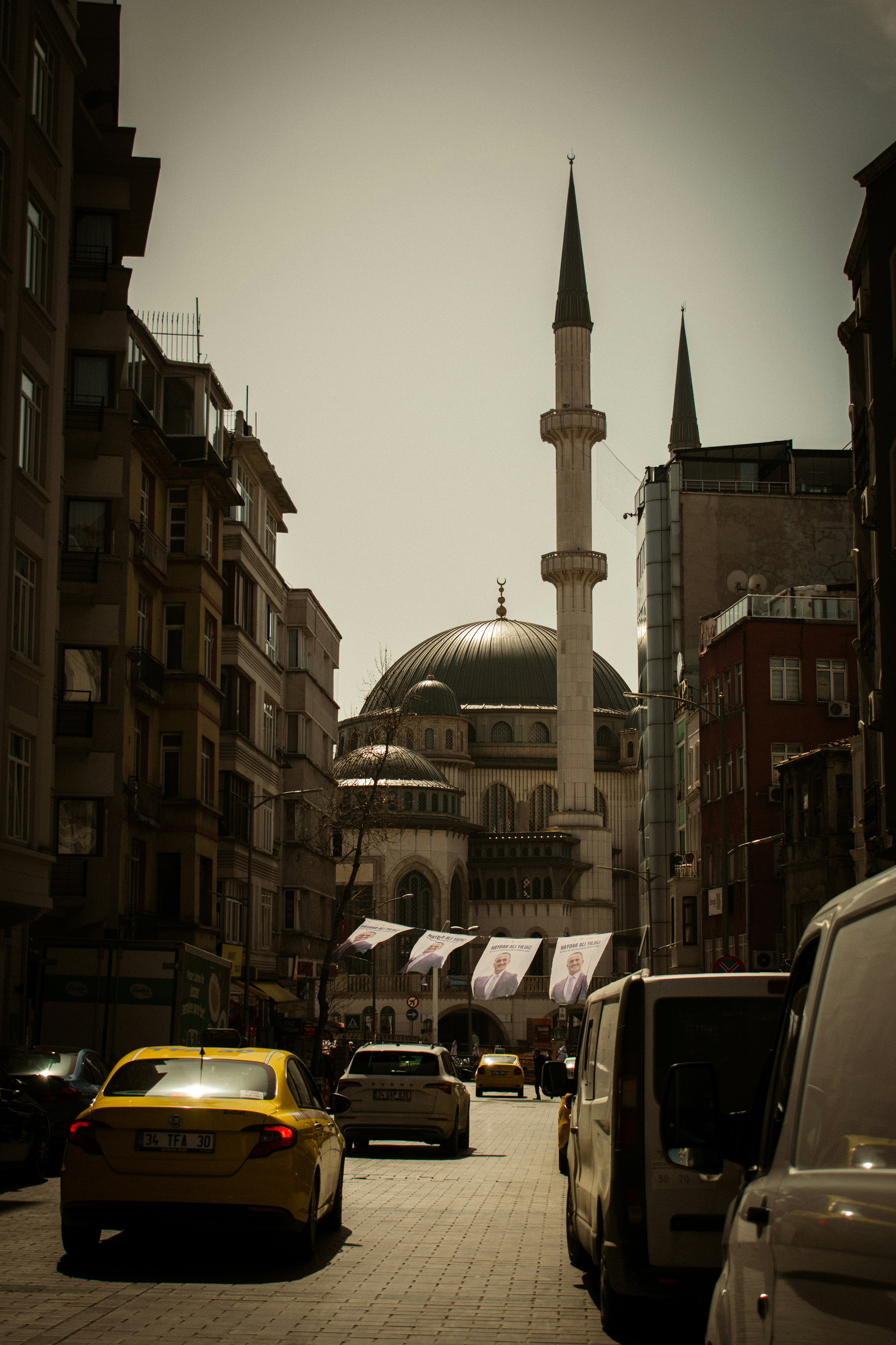 Minarets Framing a Mosque Beyond a Busy City Street