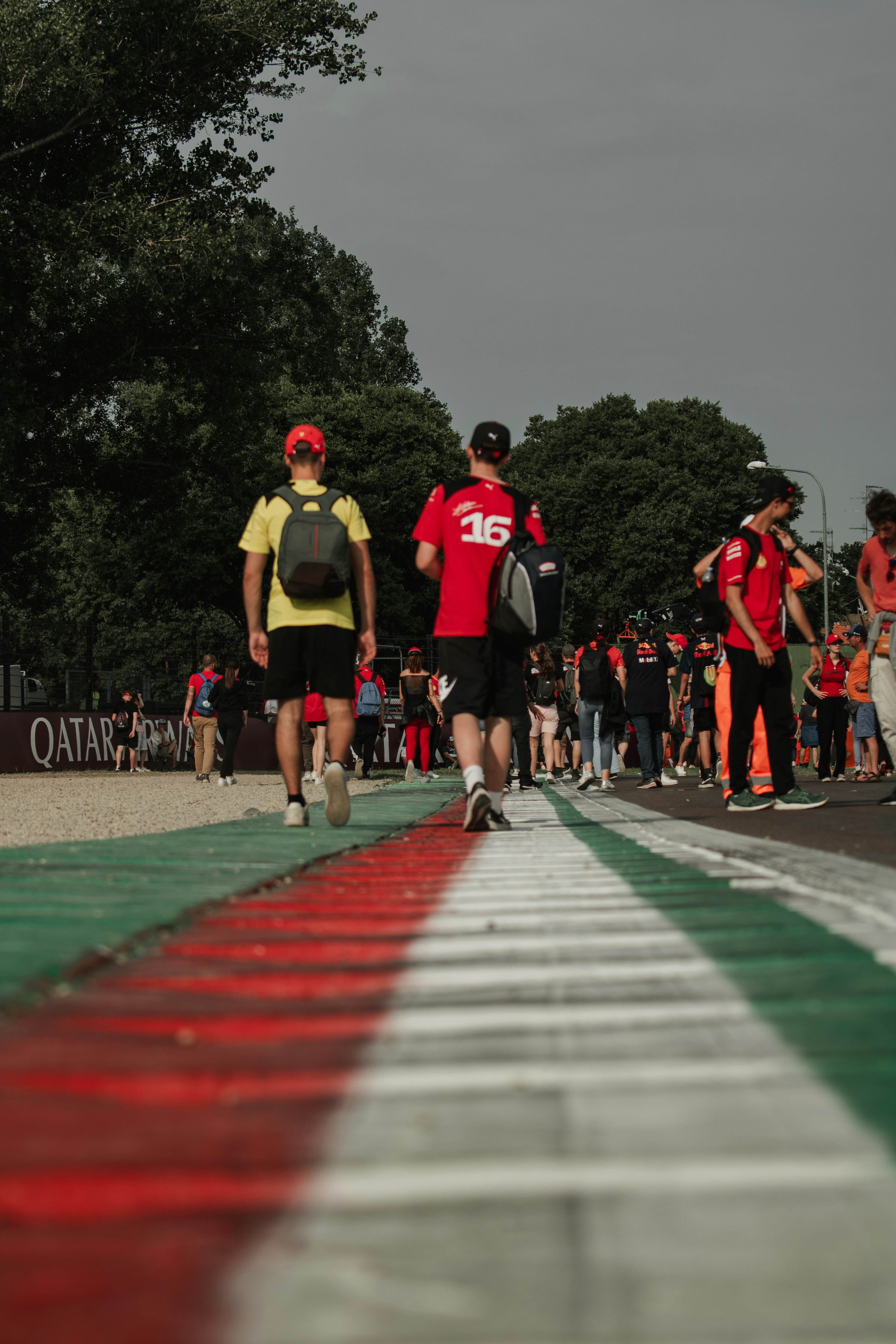 A group of people walking down a race track photo – Free Formula 1 ...