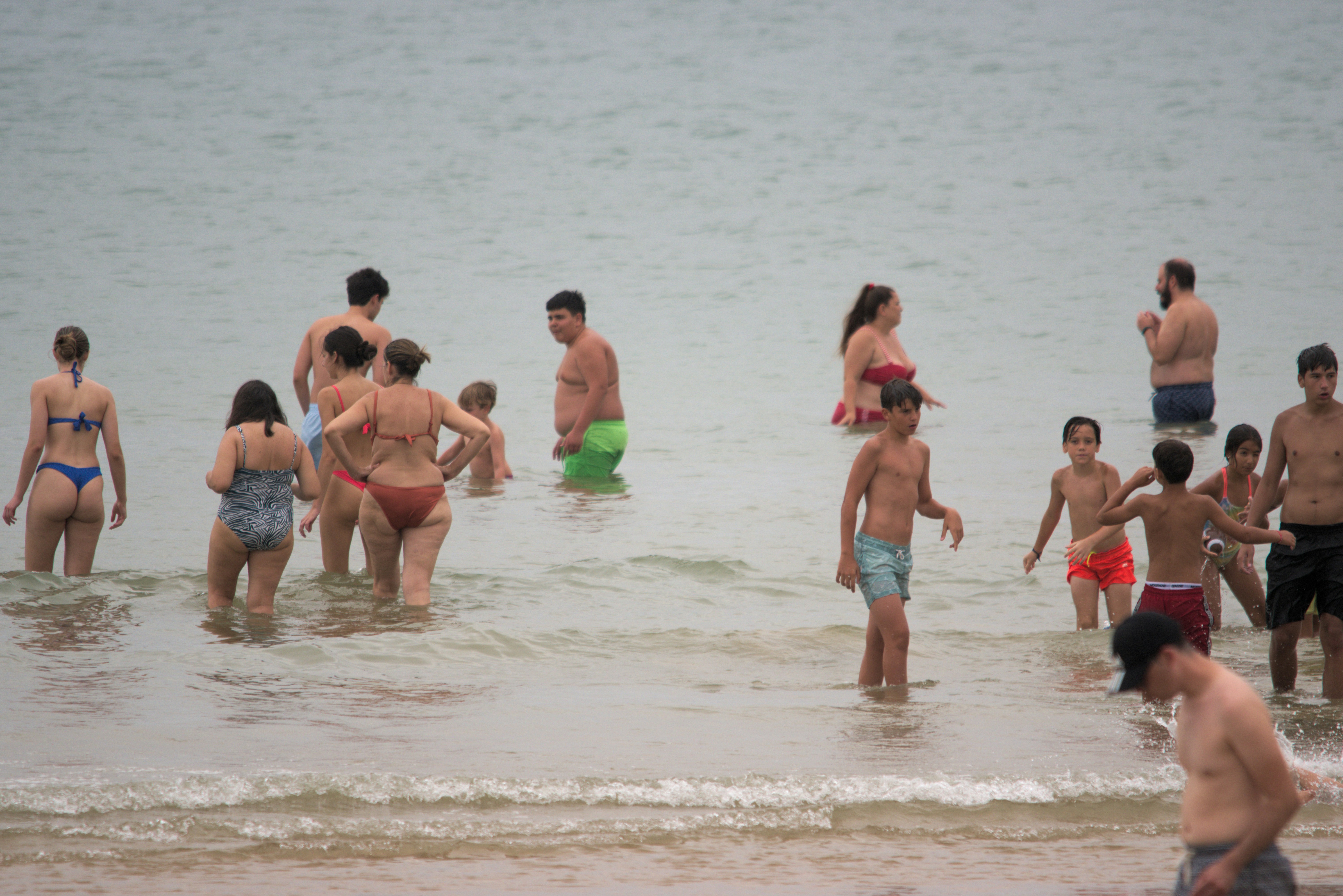Shoreline Confluence: Quiet Day Among Beachgoers