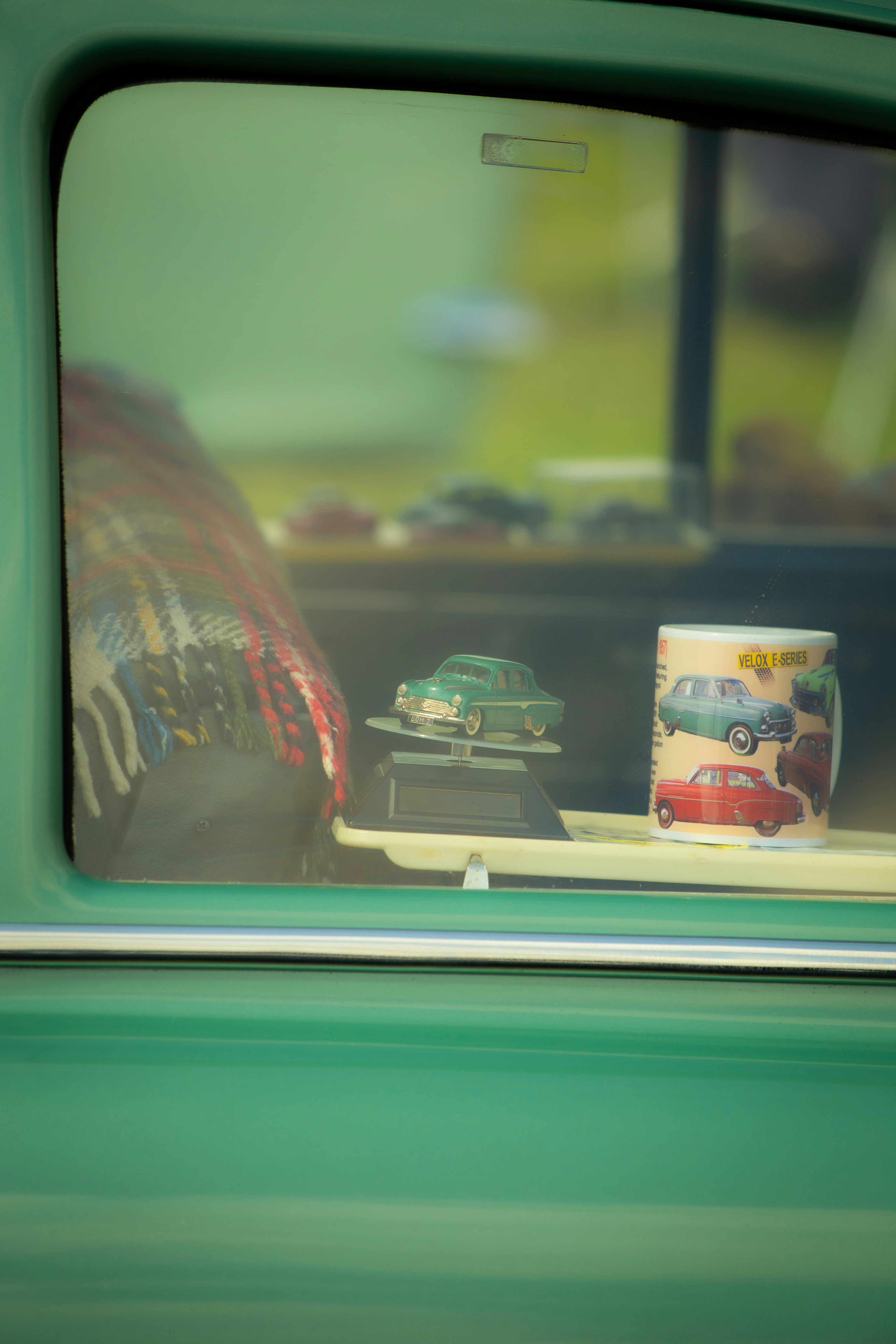 Miniature Green Car on a Car Window Display