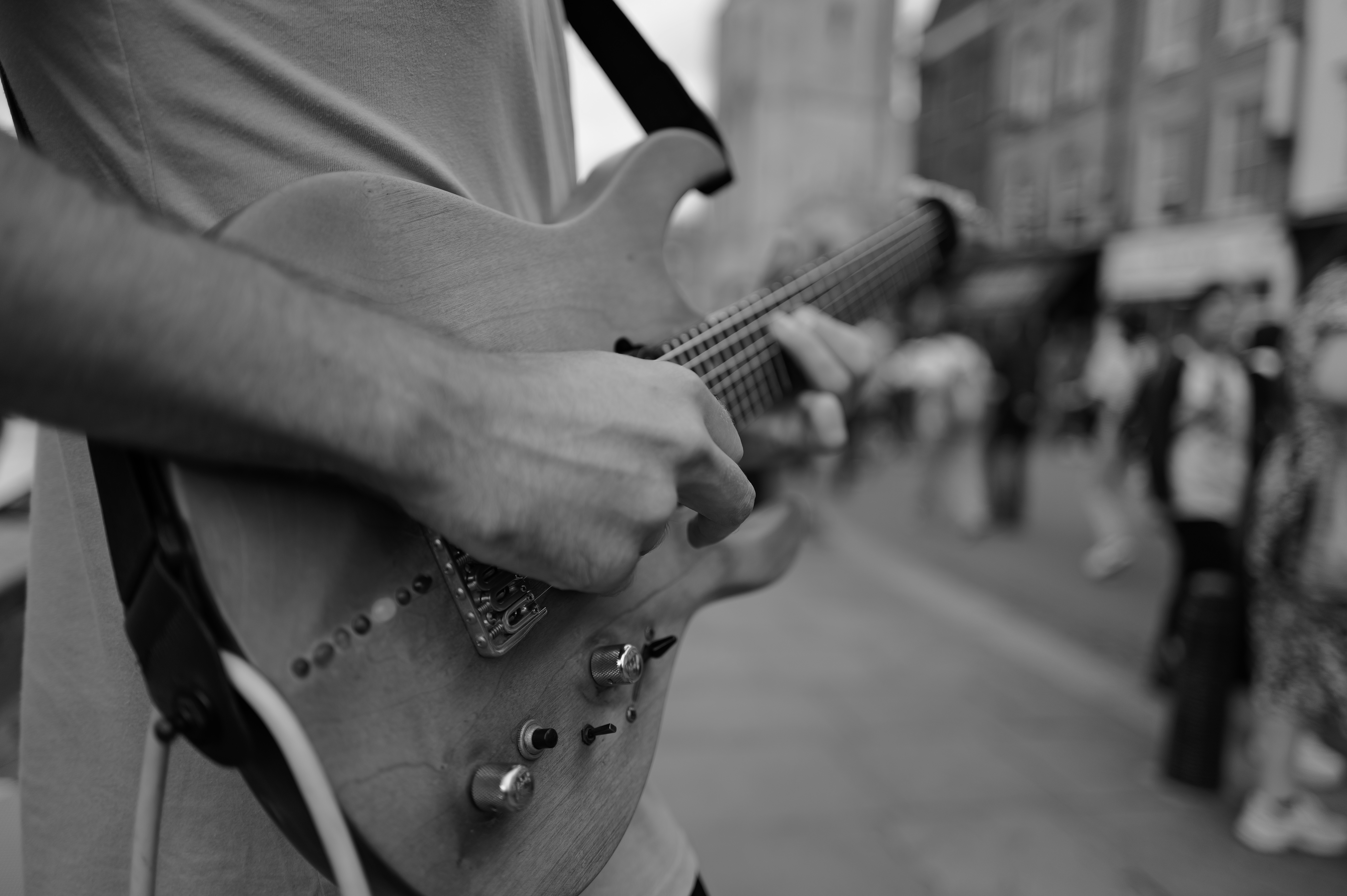 City Street Soliloquy: A Guitarist in Monochrome