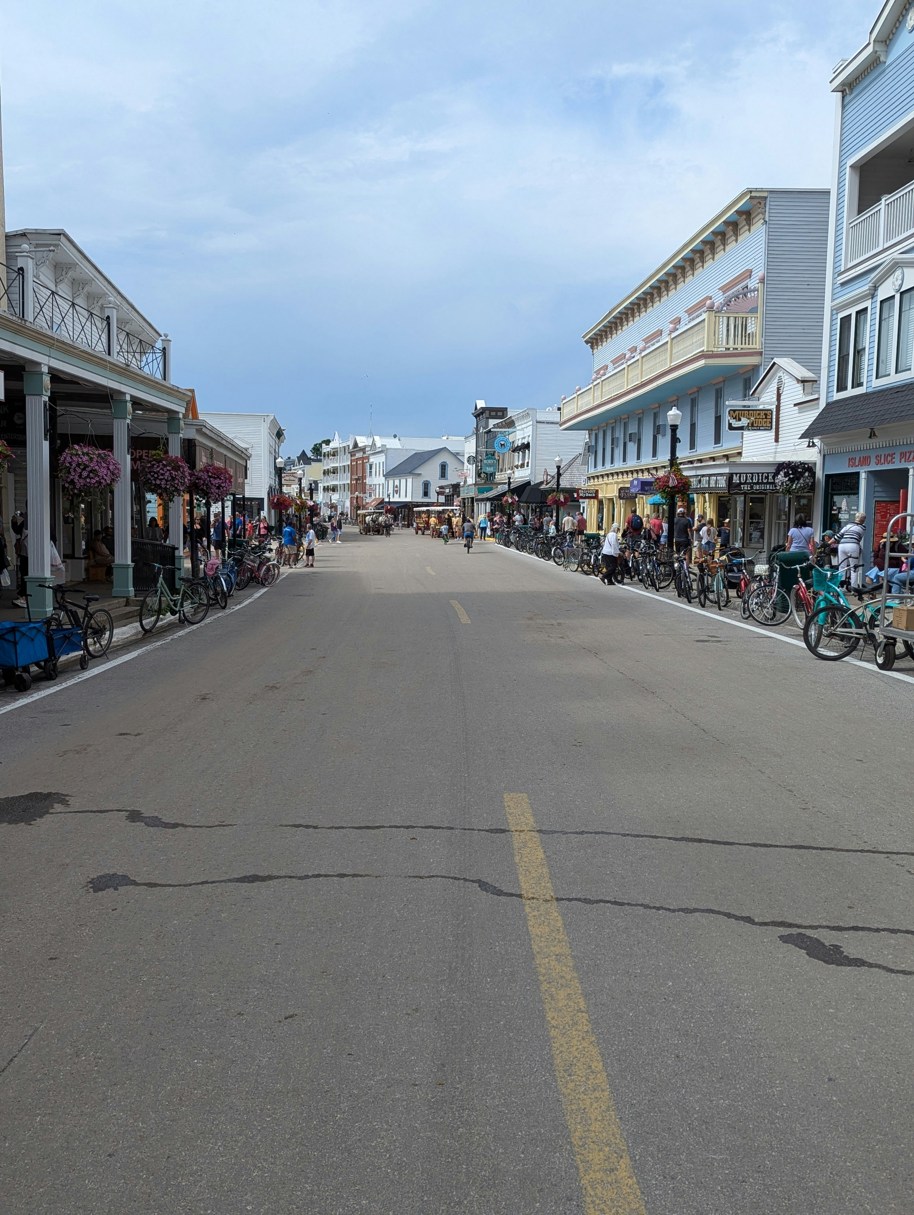 Main Street in a Painted Coastal Town with Shops and Bicycles