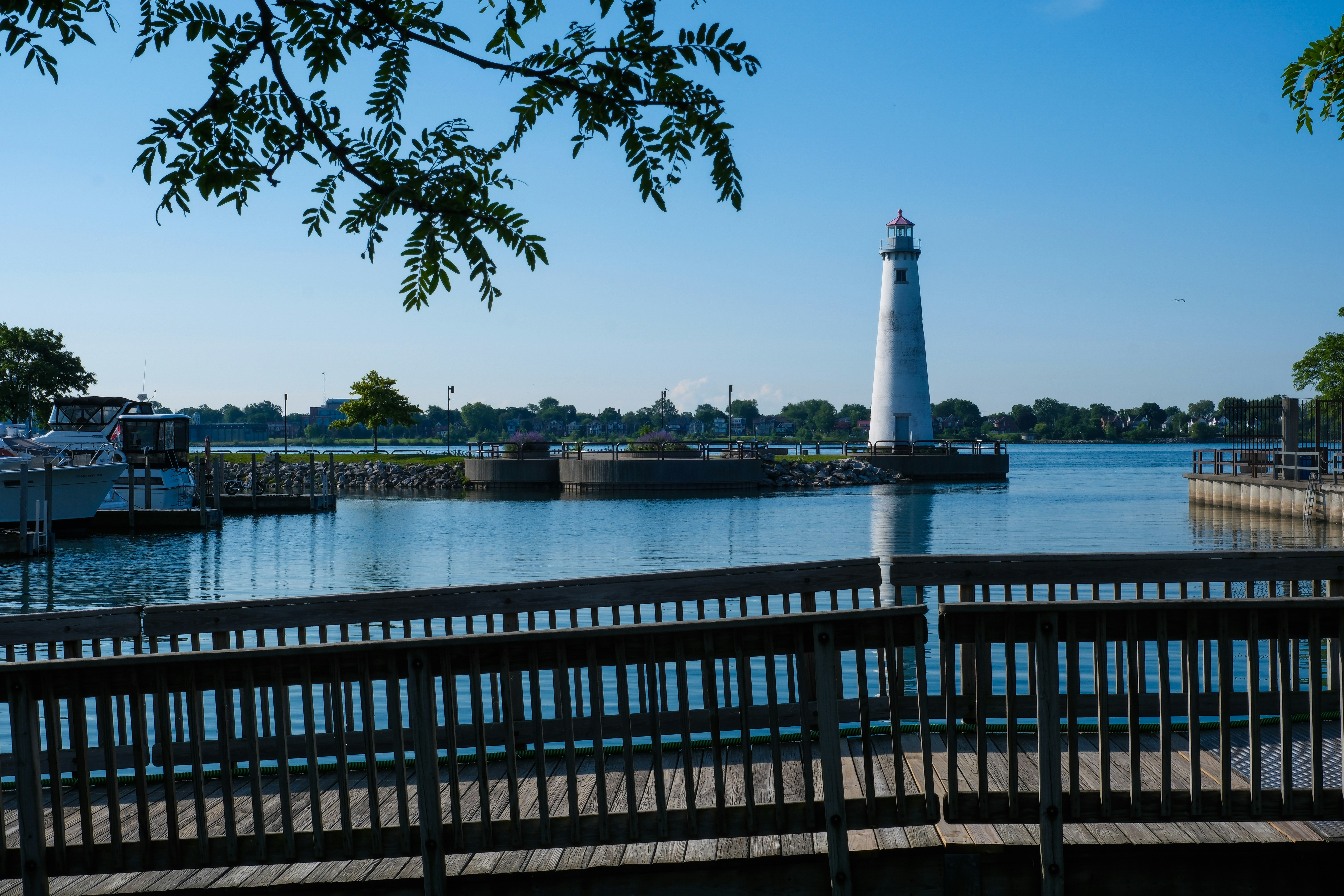 A view of a harbor with a light house in the distance photo – Free ...