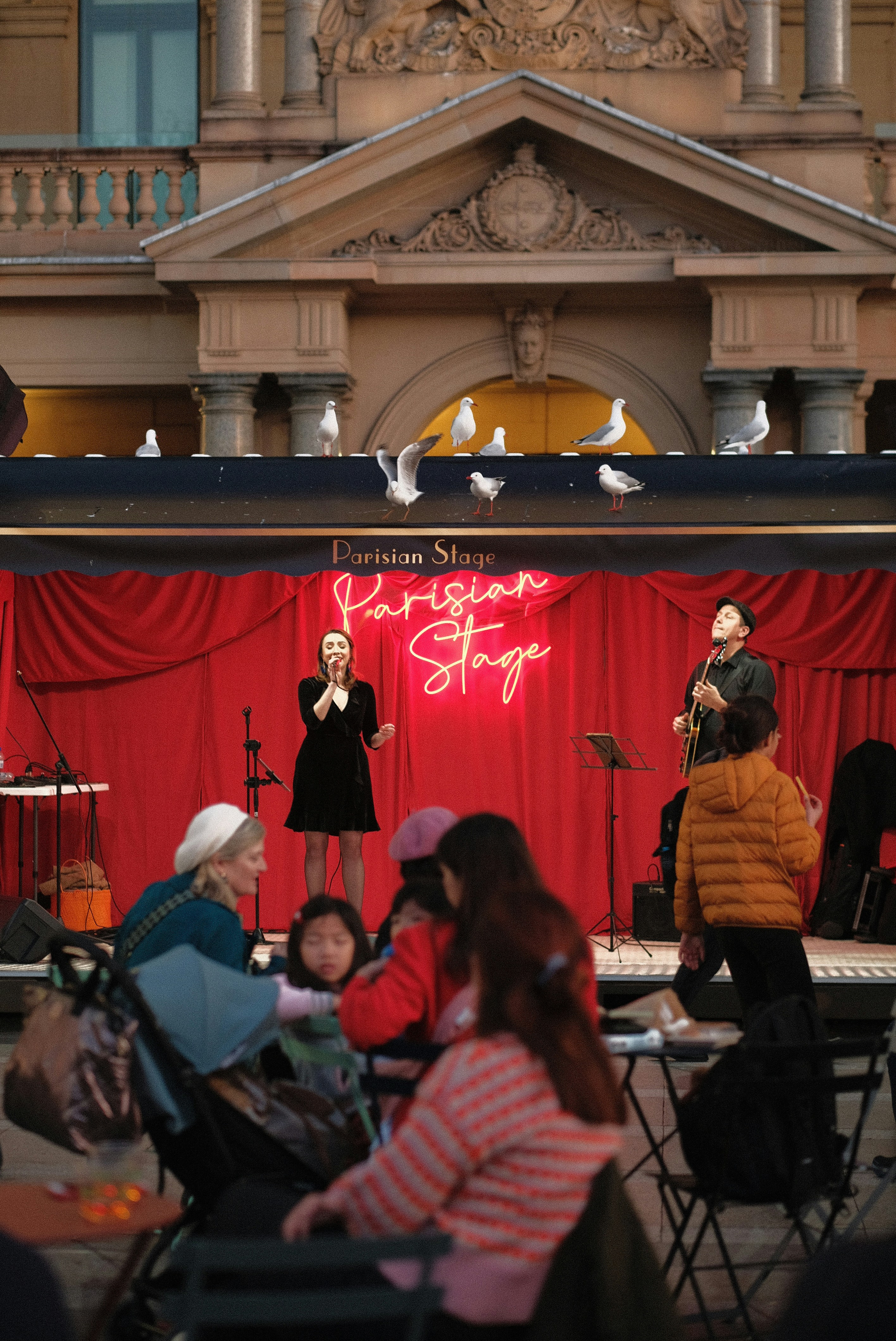Neon-Backed Duet on a Parisian Stage
