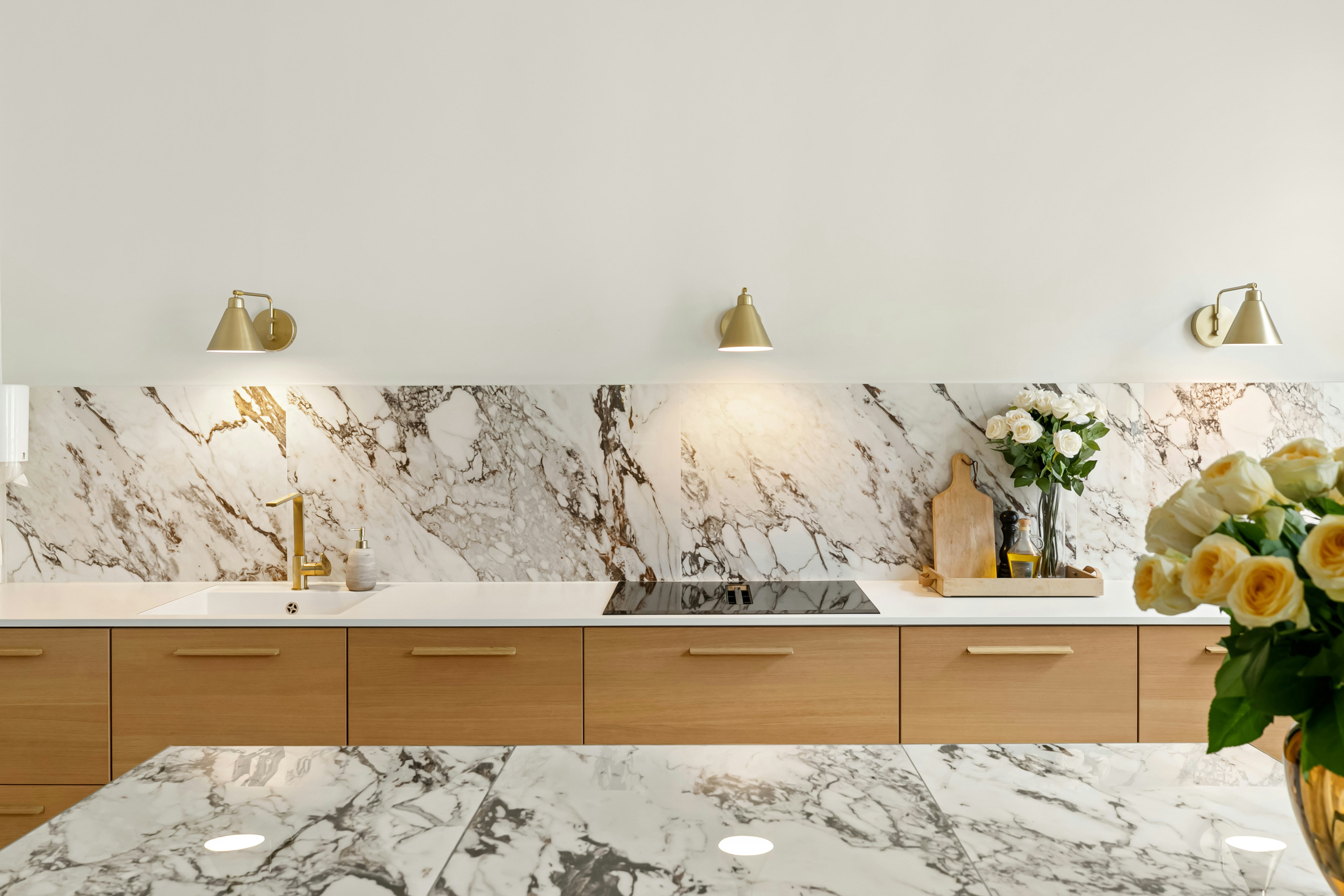 A kitchen with marble counter tops and gold accents photo – Free Image ...