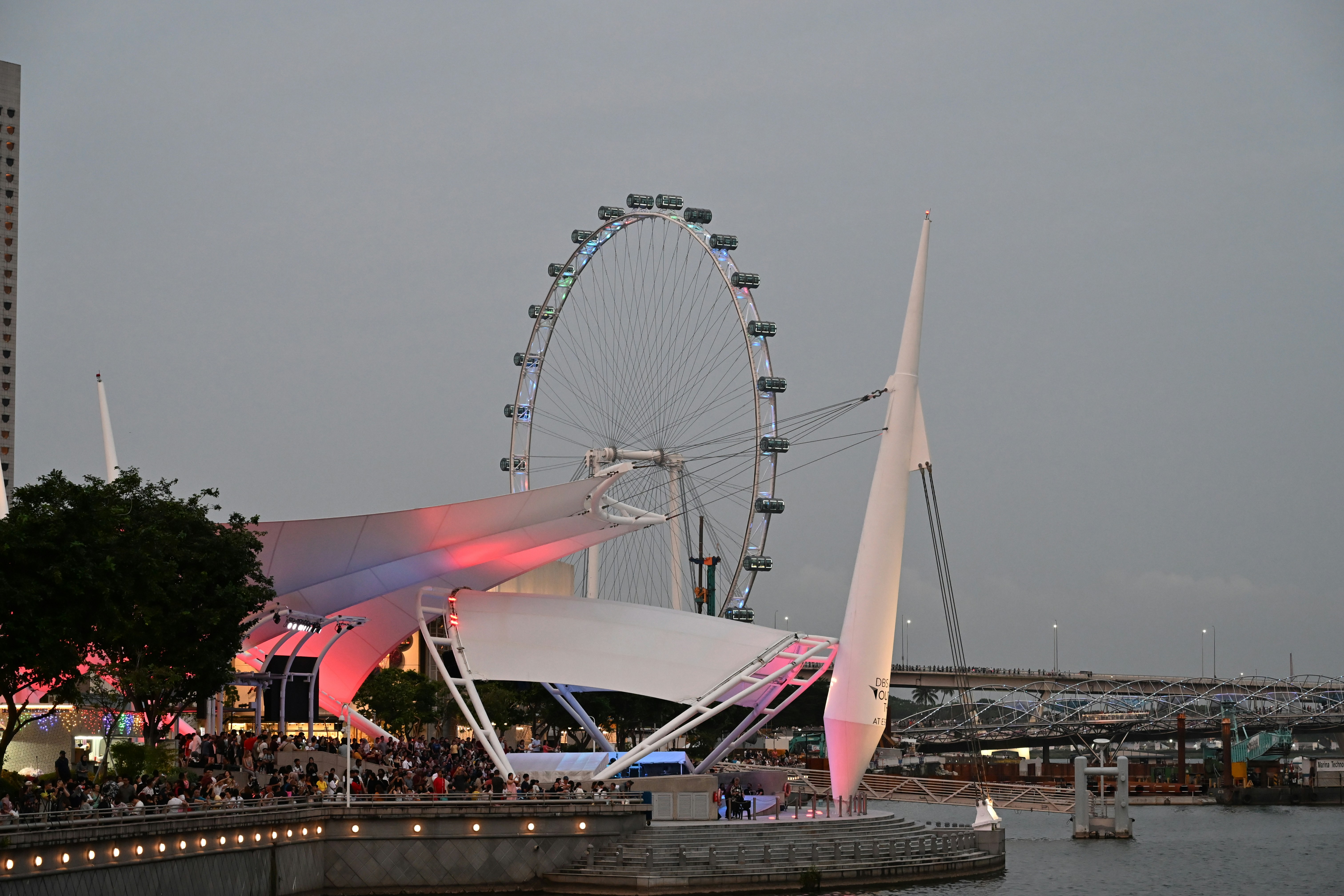 A large ferris wheel sitting next to a body of water