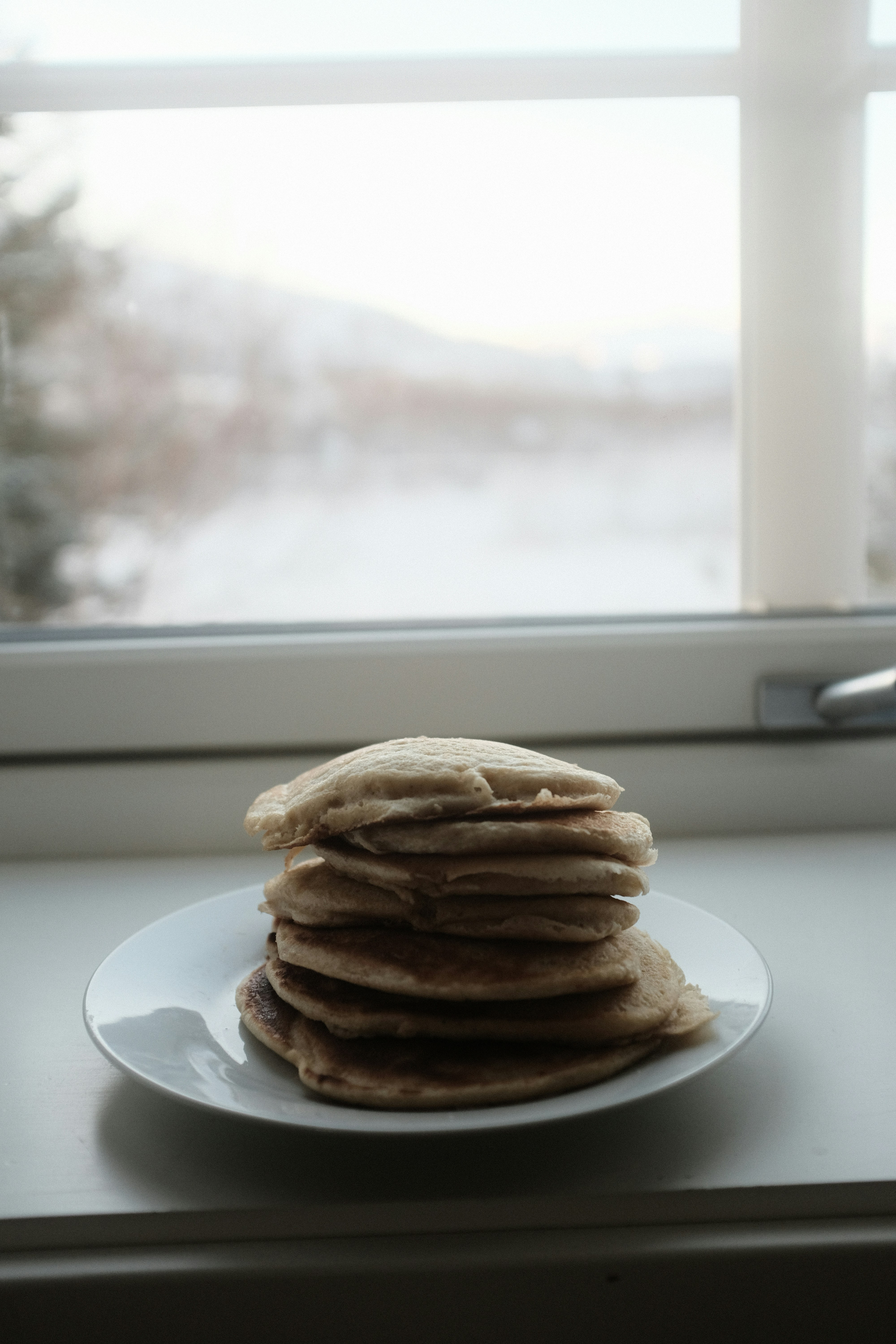 Morning Stack: Pancakes on a Windowsill in Soft Winter Light