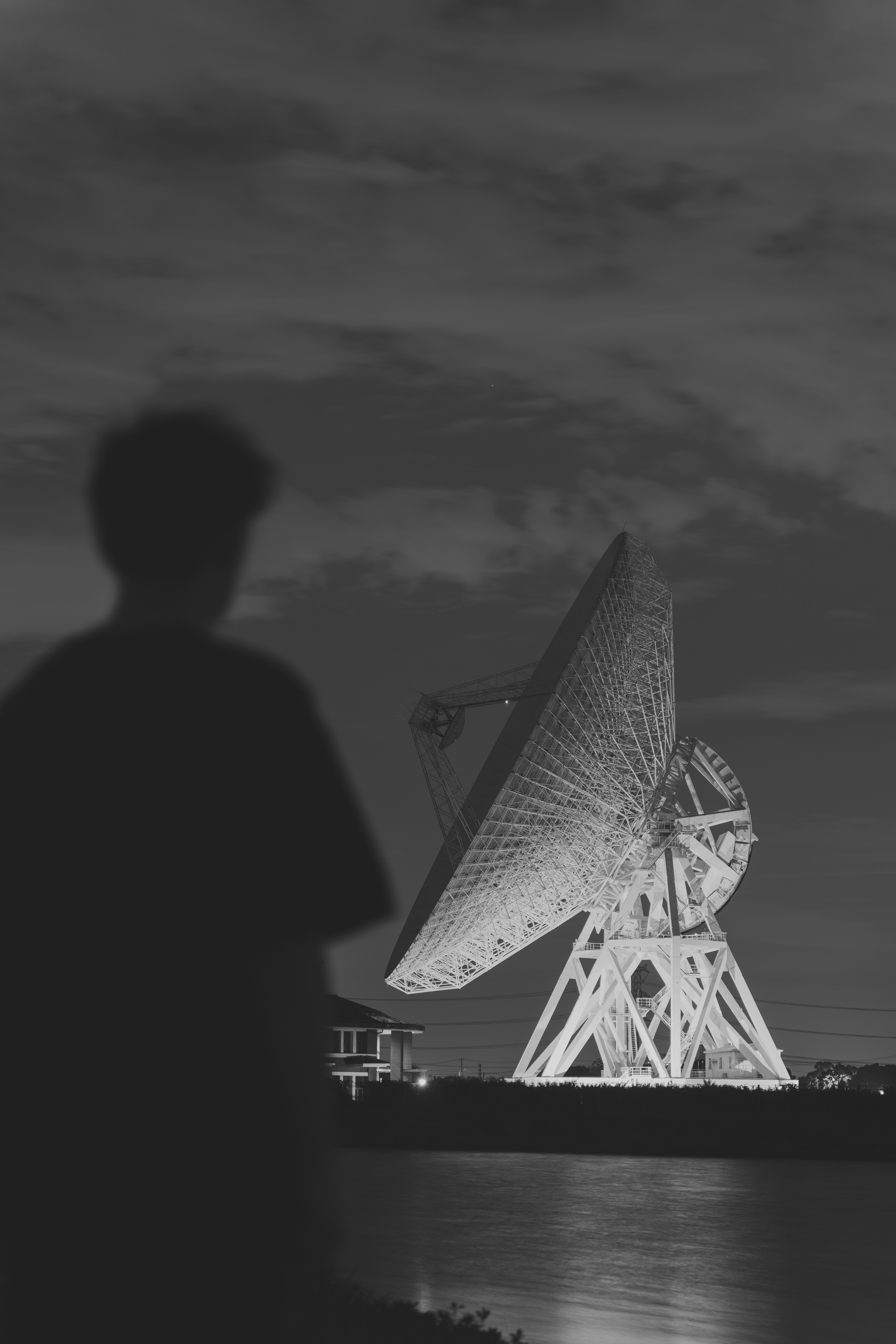 Silhouette Over Satellite Dish at Dusk